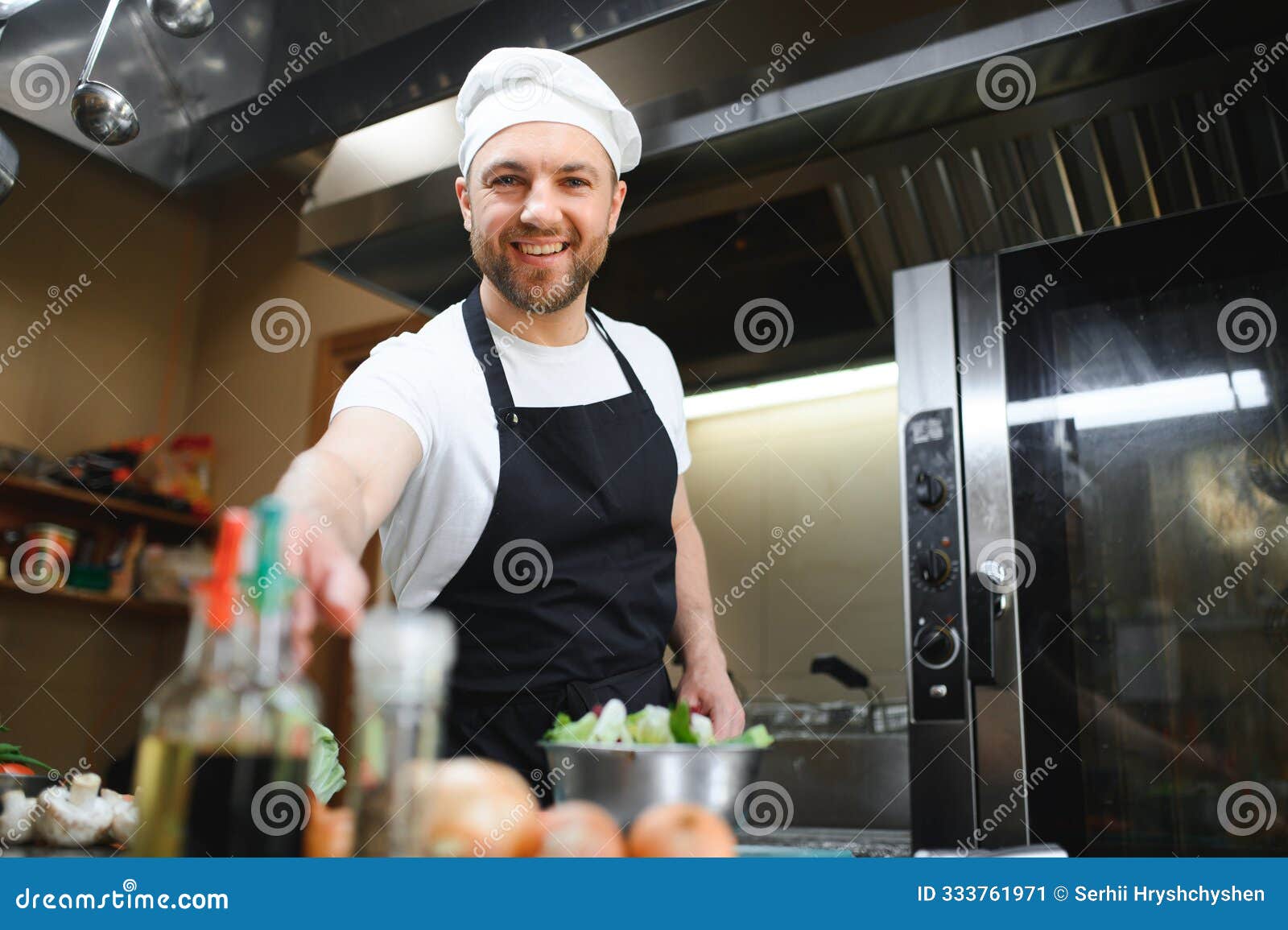 Chef Cook in Uniform Cooking in the Big Cooker at the Restaurant ...
