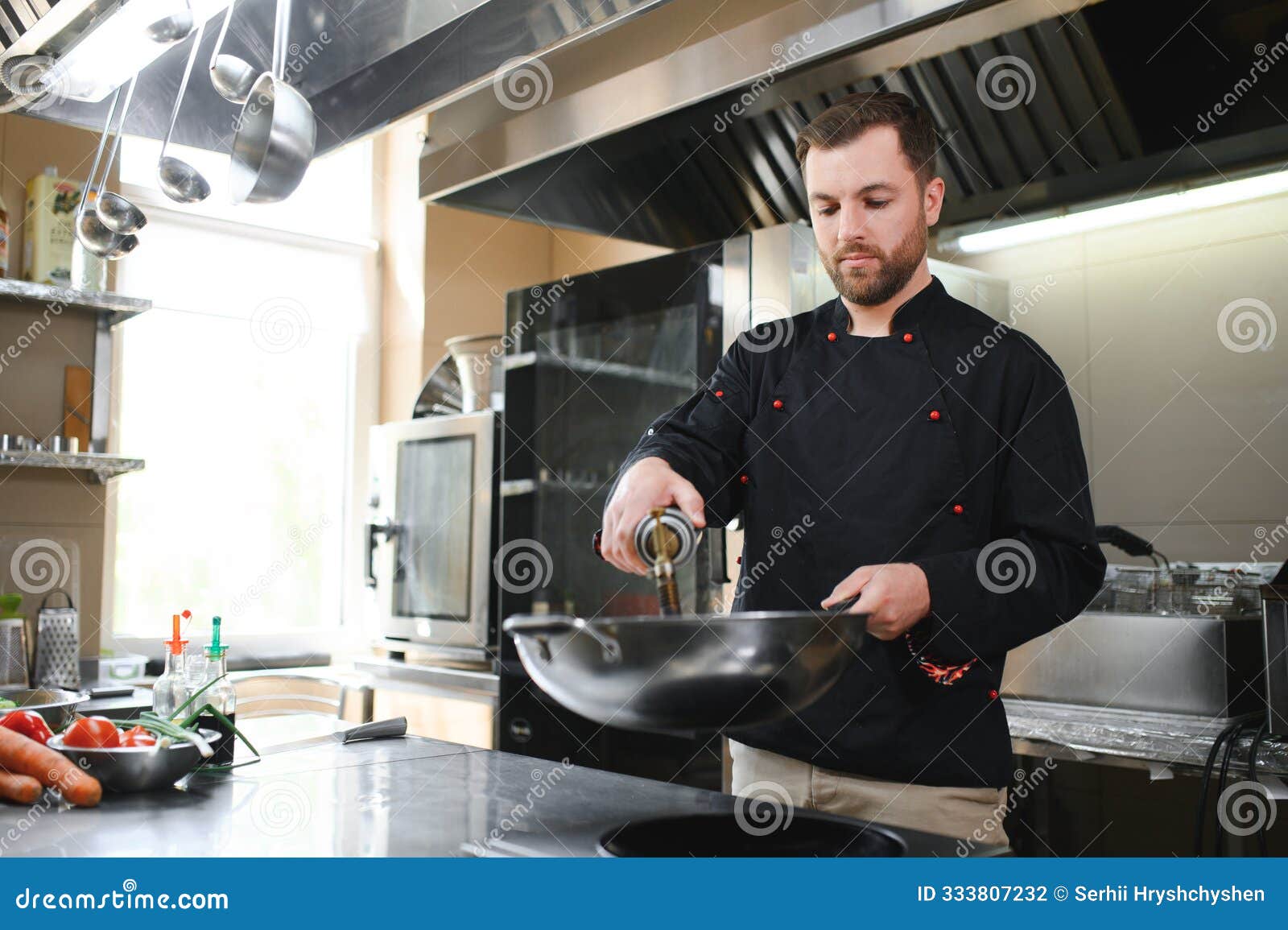 Chef Cook in Uniform Cooking in the Big Cooker at the Restaurant ...
