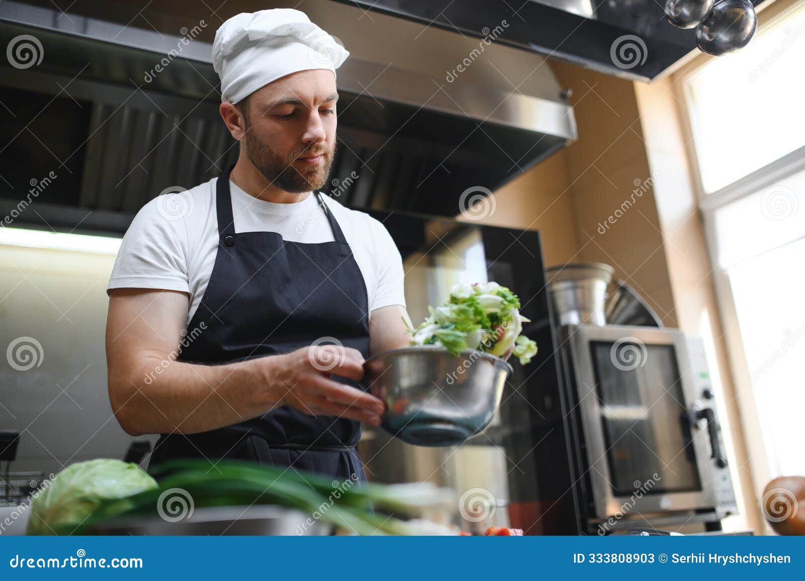 Chef Cook in Uniform Cooking in the Big Cooker at the Restaurant ...