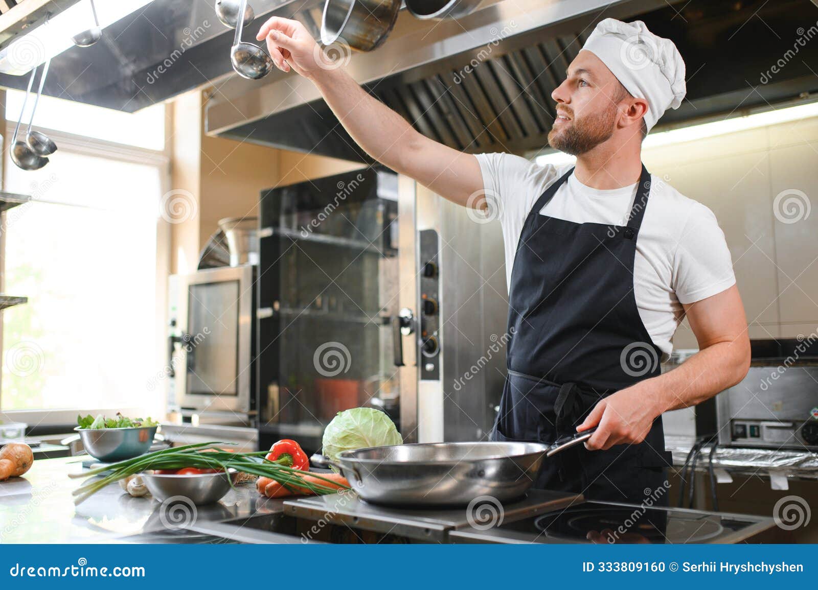 Chef Cook in Uniform Cooking in the Big Cooker at the Restaurant ...