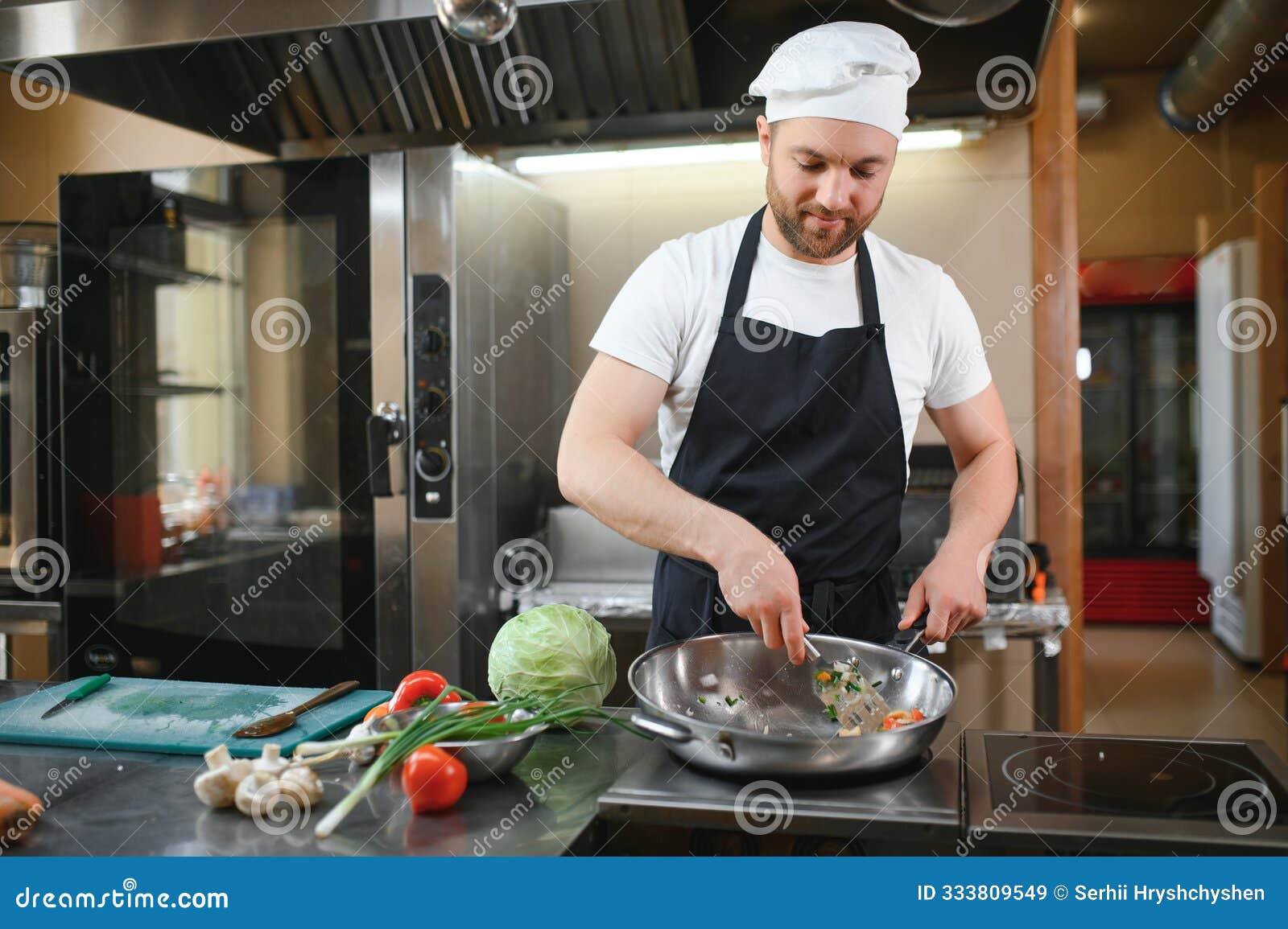 Chef Cook in Uniform Cooking in the Big Cooker at the Restaurant ...