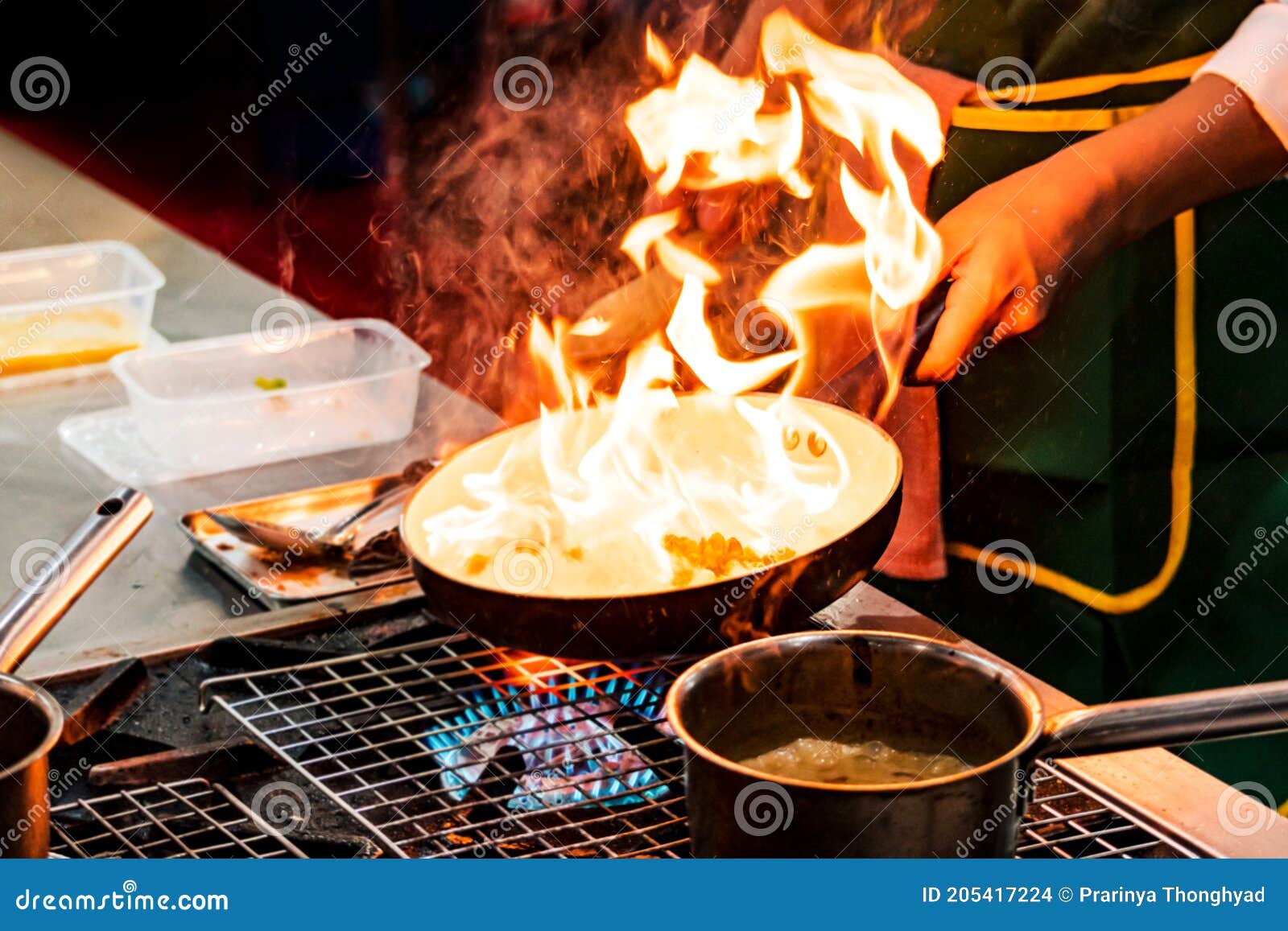 Chef Cooking with Flame in a Frying Pan on a Kitchen Stove Stock Photo ...