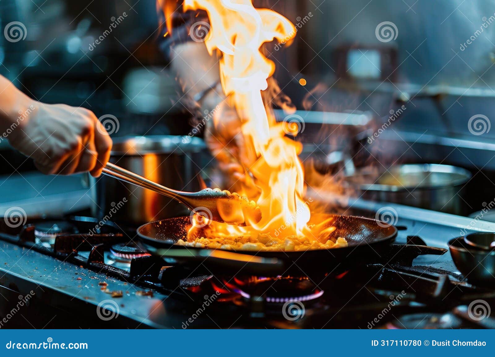 A Chef is Cooking Food in a Pan with a Lot of Fire Stock Photo - Image ...