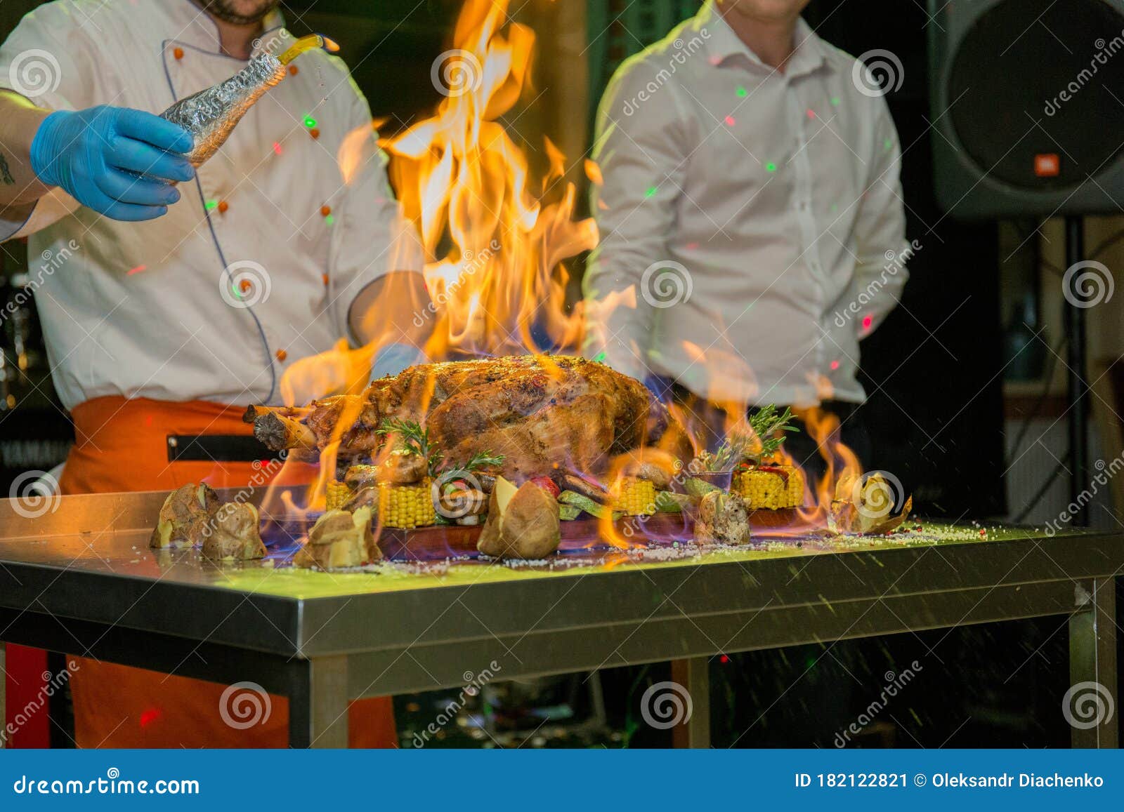 Chef Cuts Meat on Fire Flambe Ham with a Knife Stock Image - Image of ...