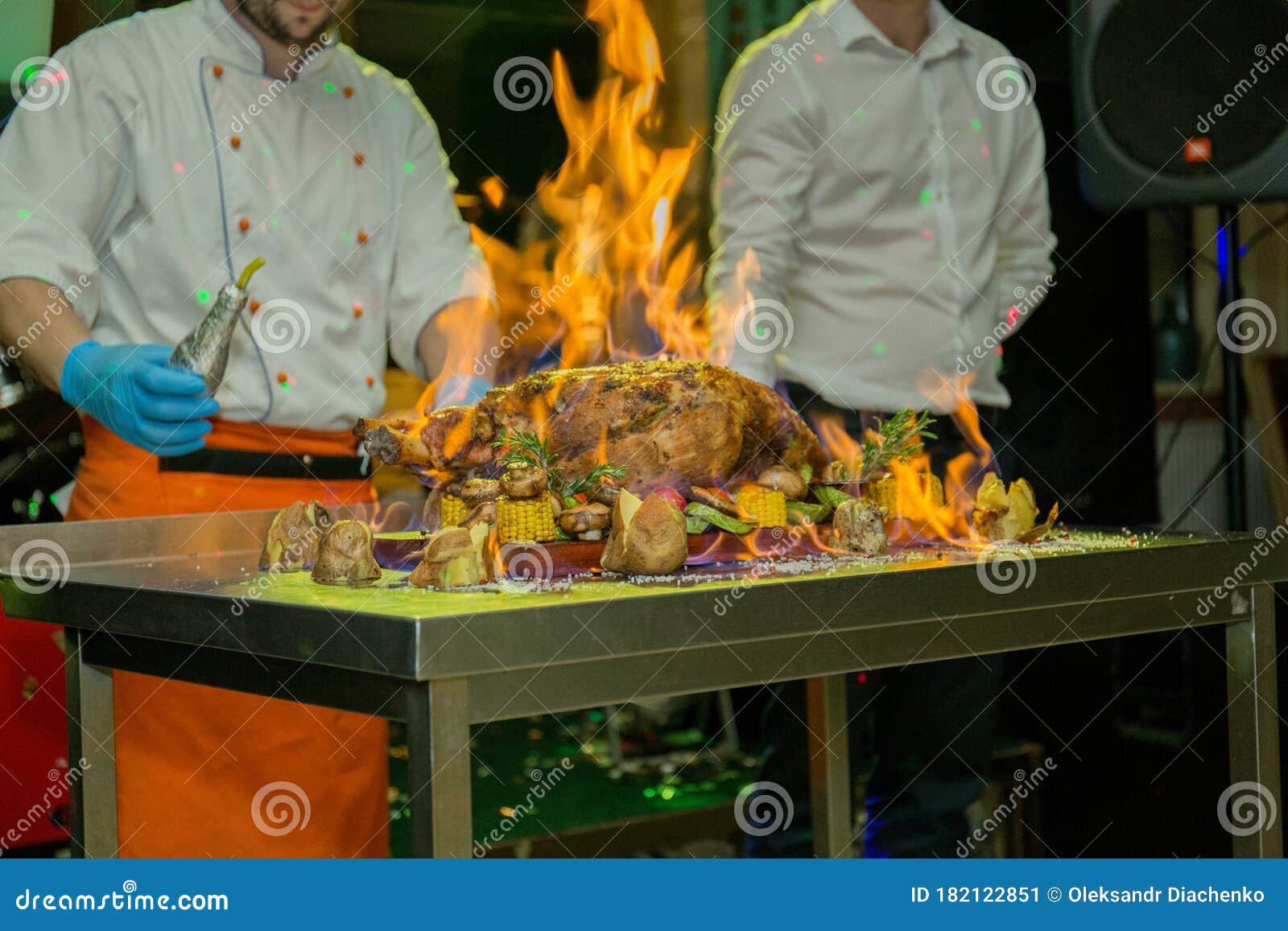Chef Cuts Meat on Fire Flambe Ham with a Knife Stock Image - Image of ...