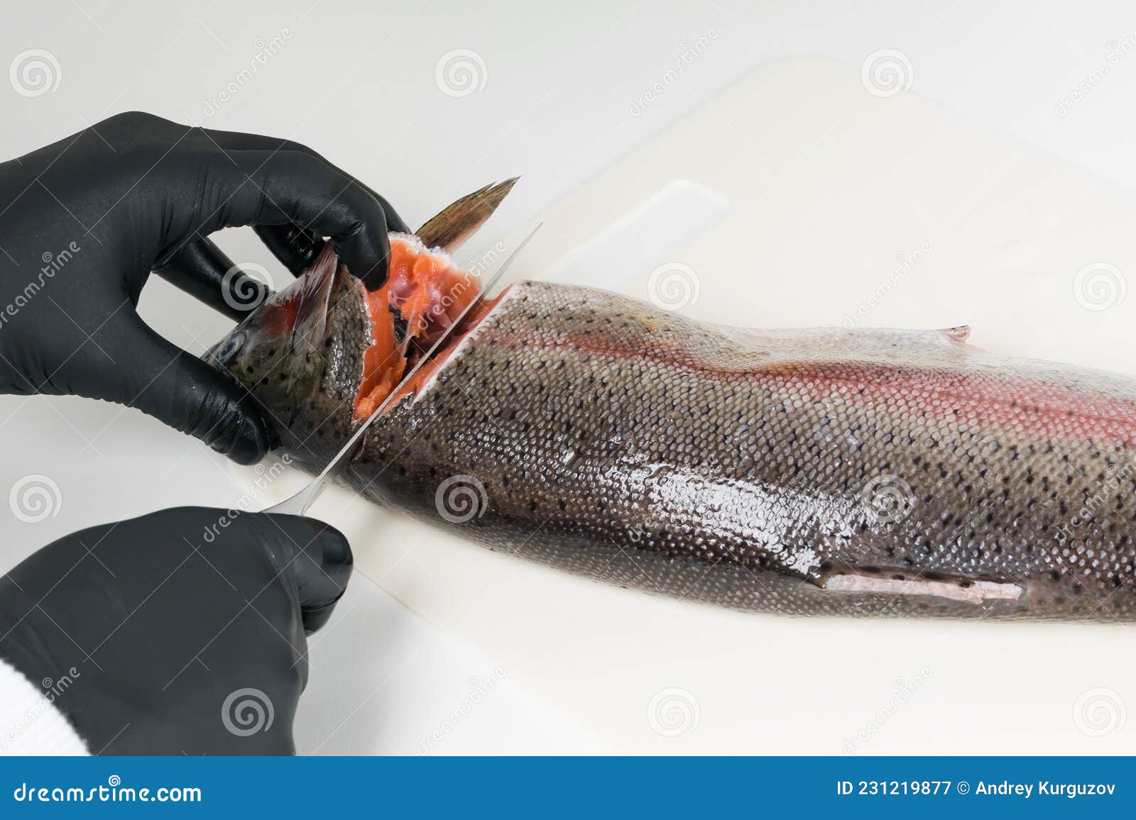 The Chef Cuts Off the Head of a Red Fish Stock Image - Image of ...