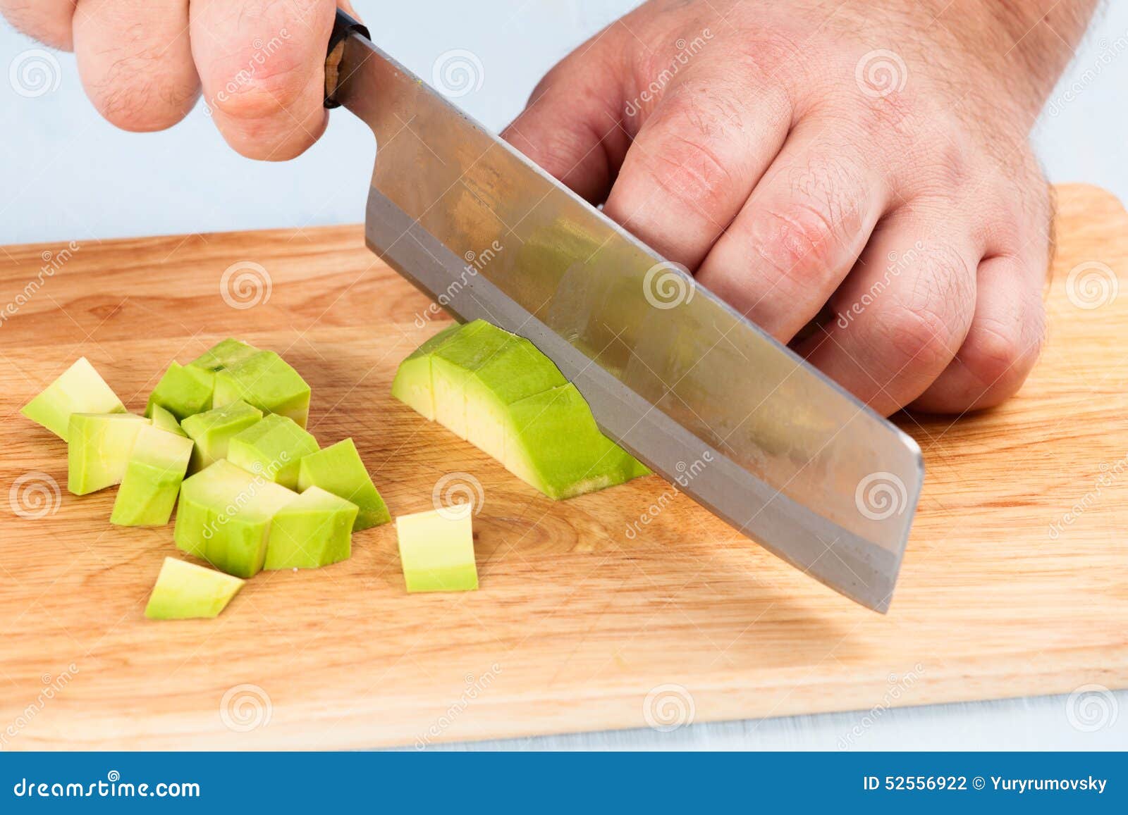 Chef cuts peeled avocado stock photo. Image of table - 52556922