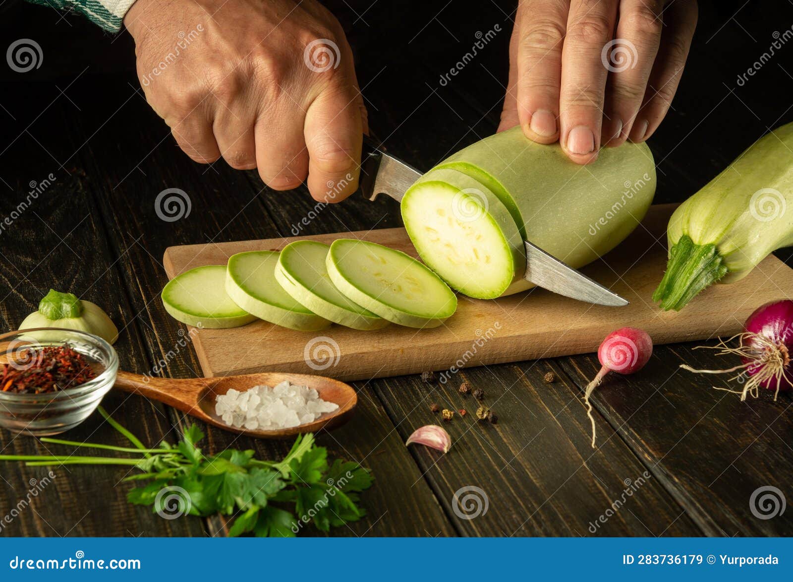 The Chef Cuts Zucchini with a Knife before Roasting with Vegetables and ...