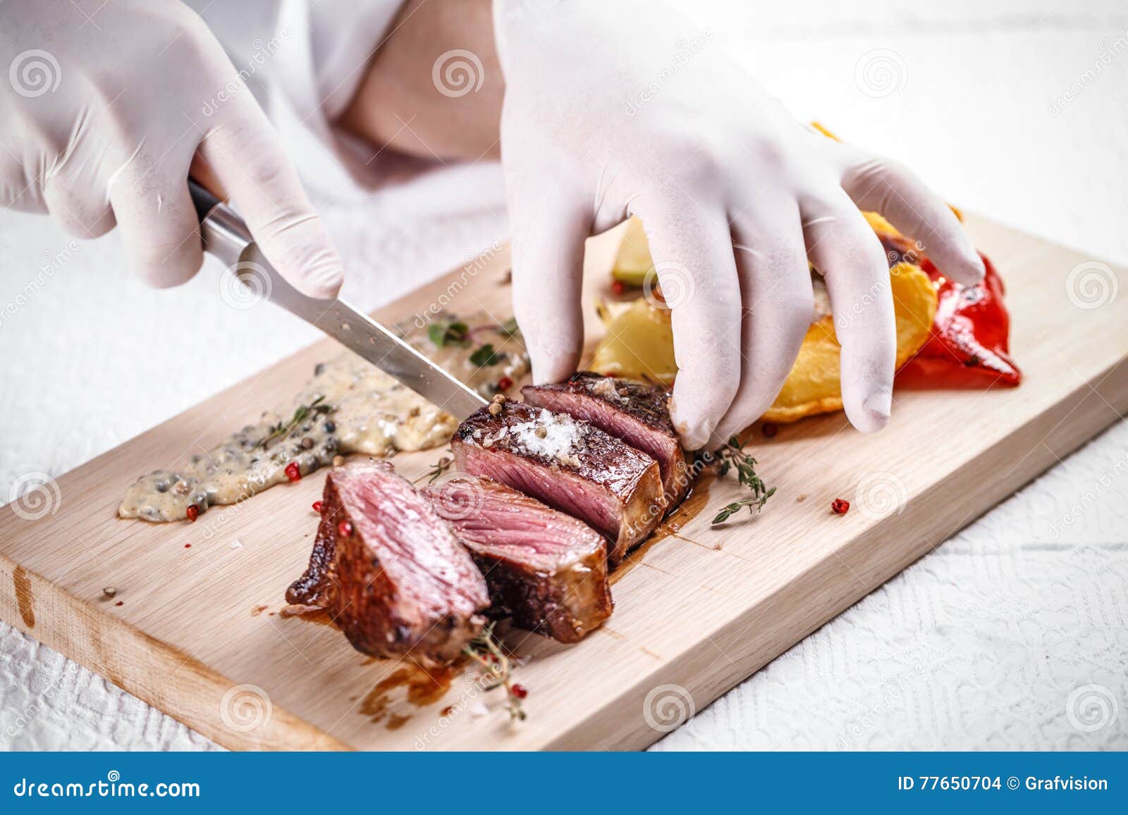 Chef cutting beef steak stock photo. Image of restaurant - 77650704