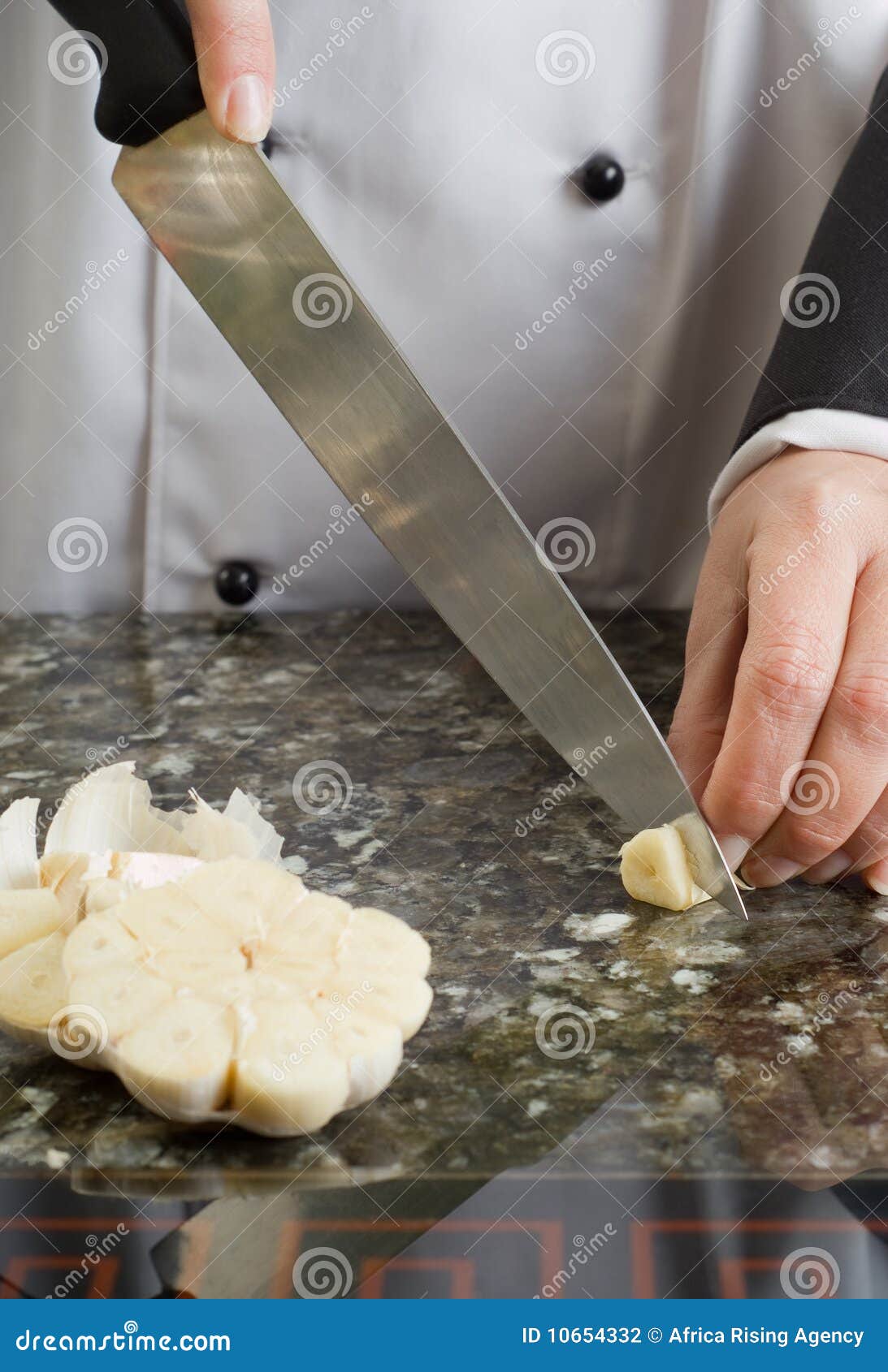 Chef Cutting Clove of Garlic Stock Photo - Image of reflection ...