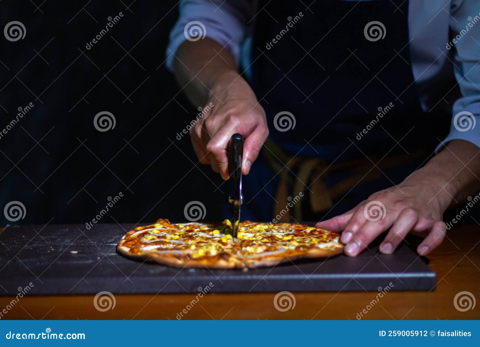 The cook cuts the pizza, stock photo. Image of material - 259005912
