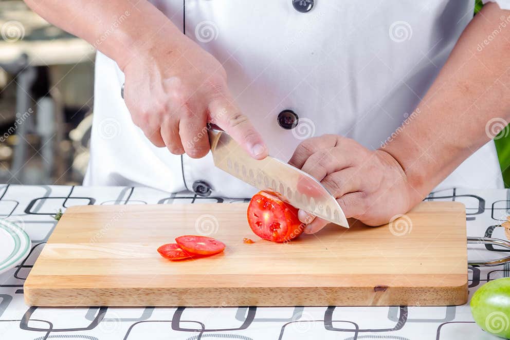 Chef cutting tomato stock image. Image of eatery, freshness - 66494733