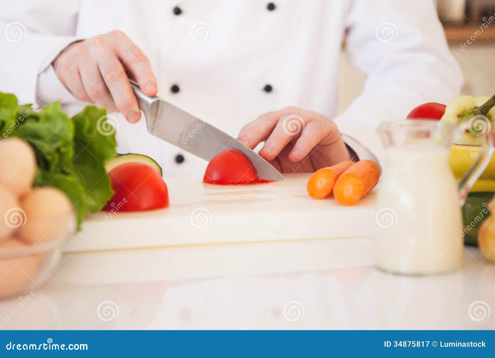 Chef Cutting a Tomato stock image. Image of knife, food - 34875817