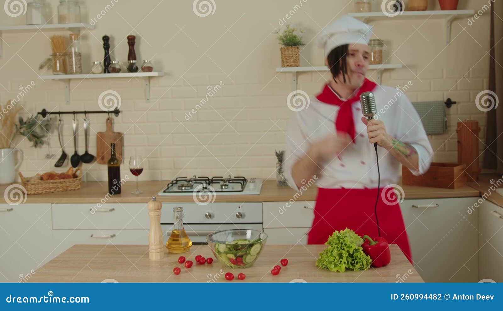 Chef with Dreadlocks Singing into Microphone in Kitchen. Happy Man in ...