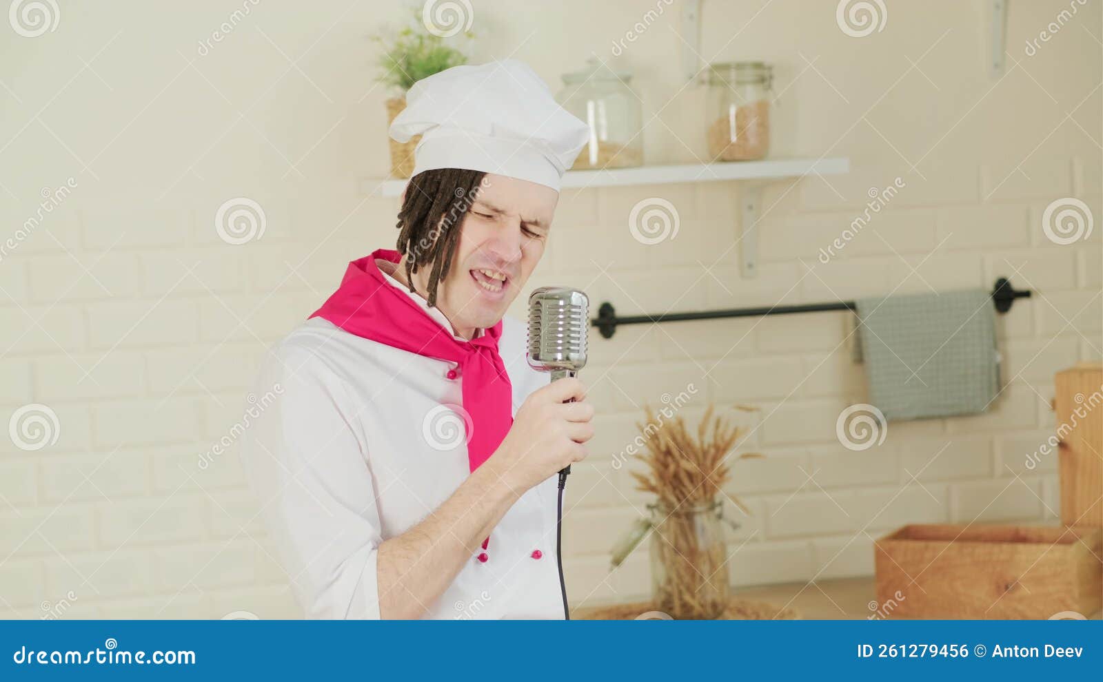 Chef With Dreadlocks Singing Into Microphone In Kitchen Happy Man In