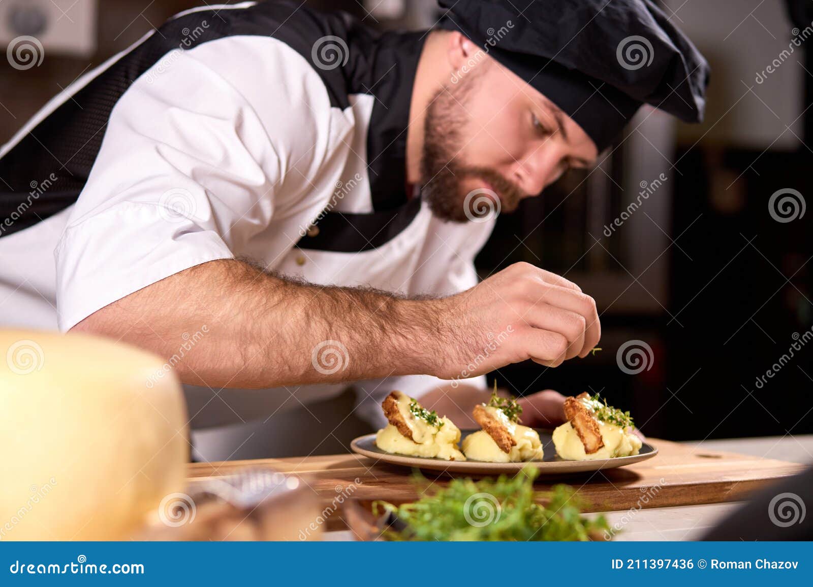Chef Dressing Salad with Greens, Adding Some Ingredients Stock Photo ...