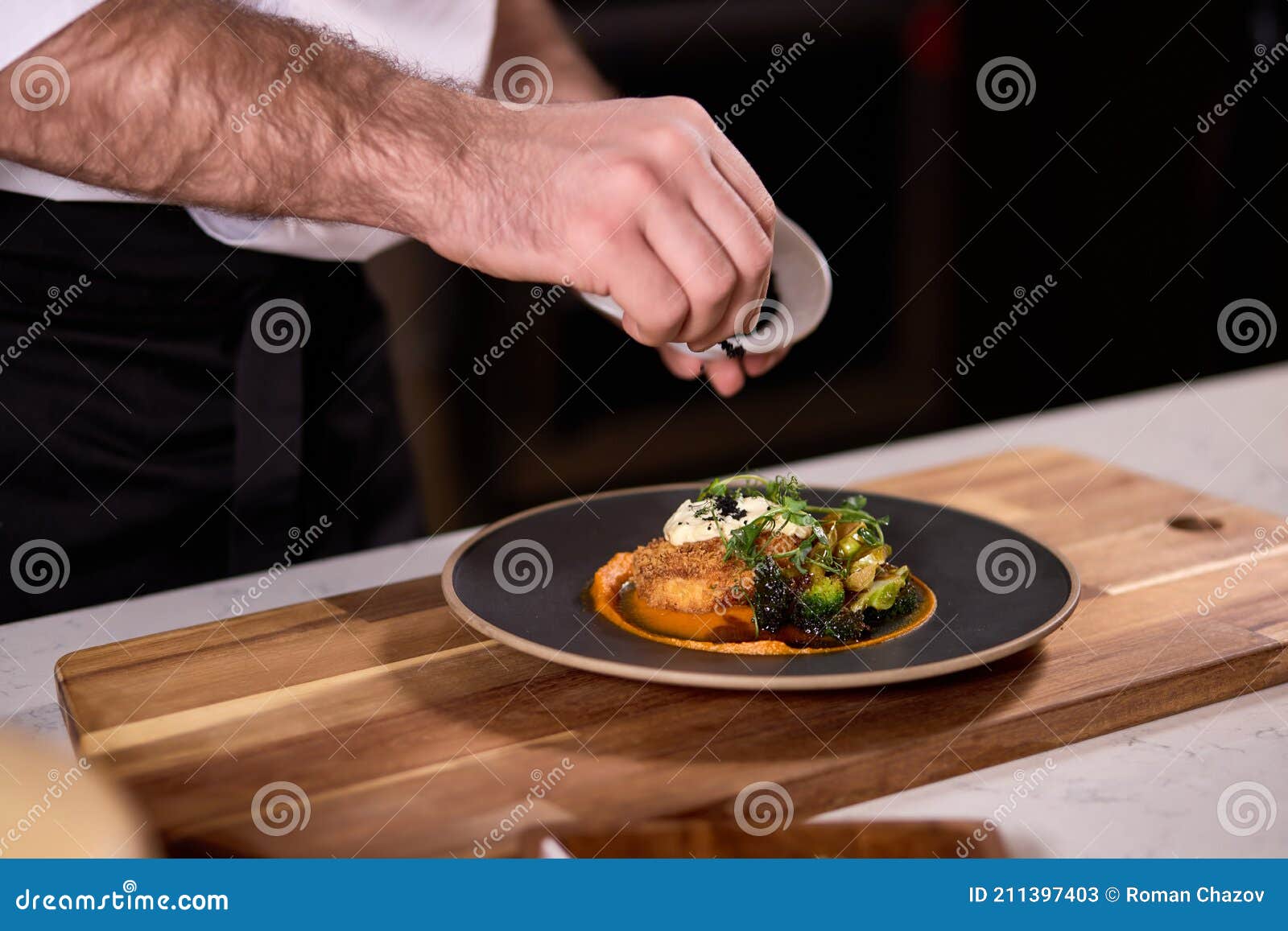 Chef Dressing Salad with Greens, Adding Some Ingredients Stock Image ...