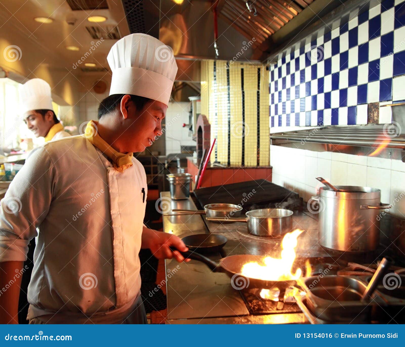 Chef flambe cooking stock photo. Image of person, people - 13154016