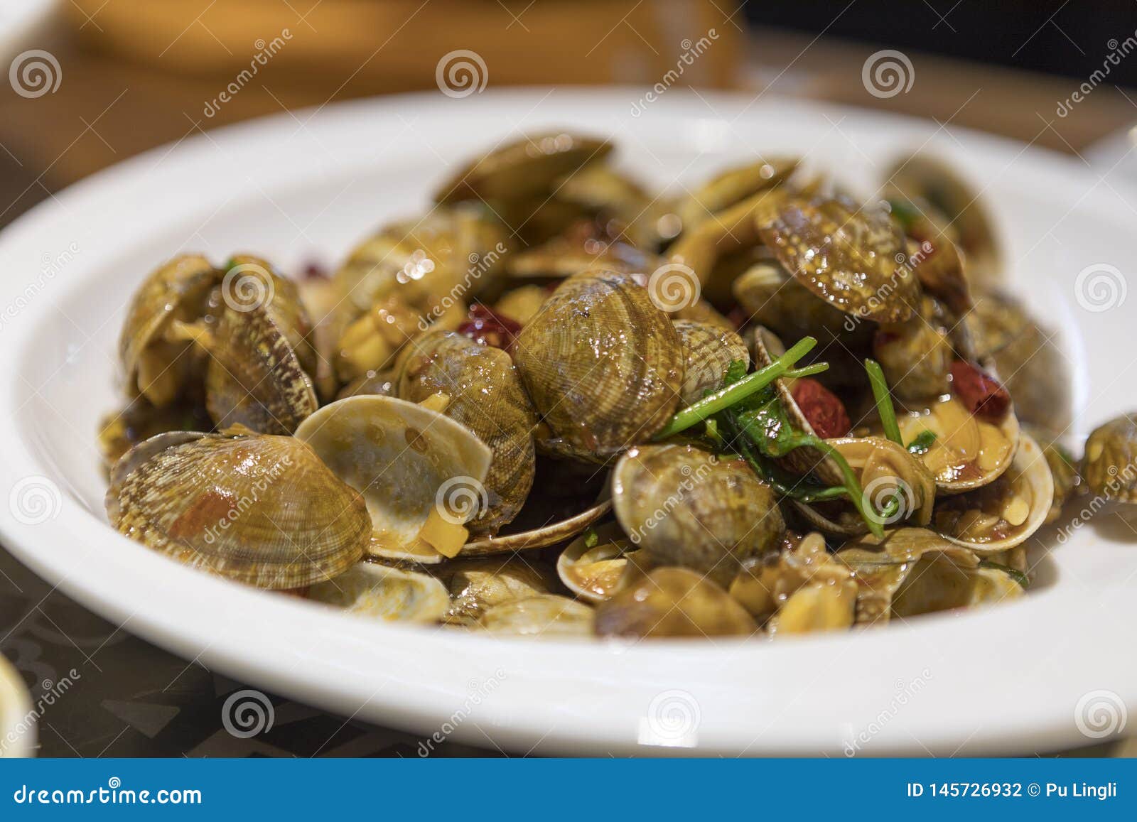 Chef Fried Fish With Small Red Hot Pepper On A Griddle Against A Black ...