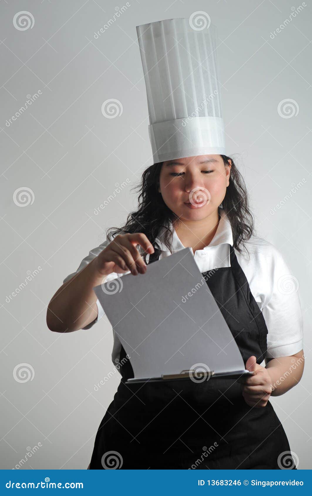 Chef Going Over Cooking Checklist Stock Photo | CartoonDealer.com #13683246