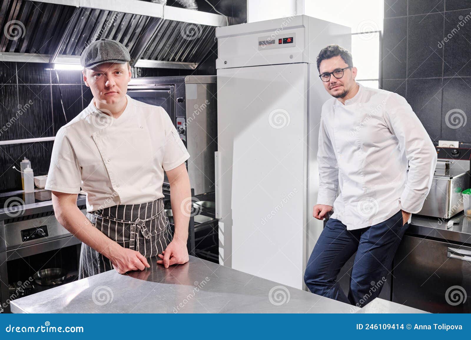 Chef and His Assistant Working in Commercial Kitchen Stock Photo ...
