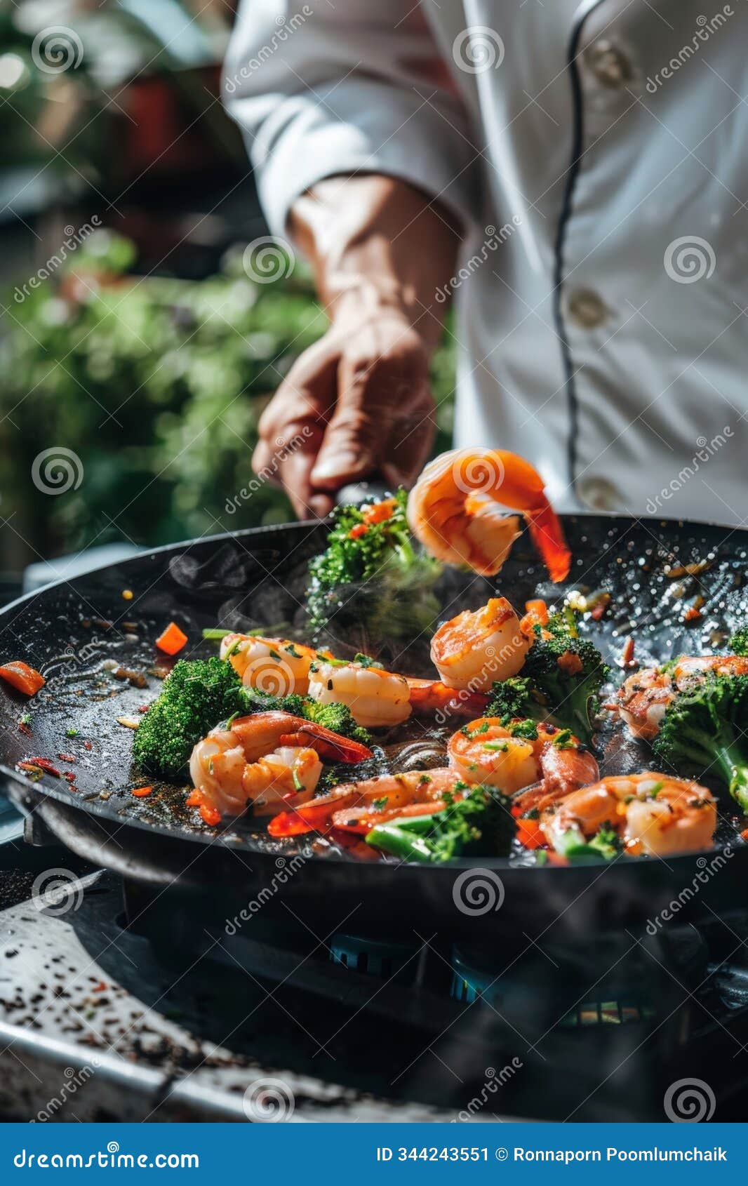A Chef is Holding a Frying Pan with Broccoli and Shrimp Rolling on the ...