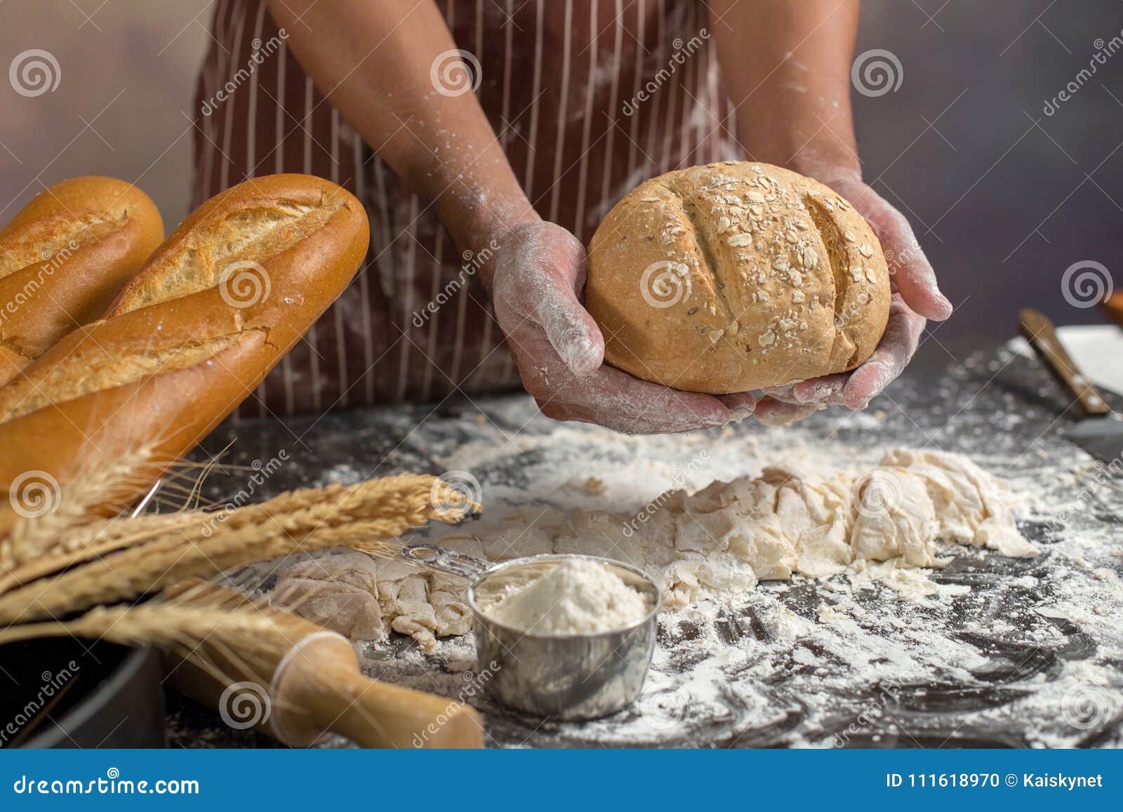Chef Holds the Fresh Bread in Hand. Man Preparing Buns at Table Stock ...