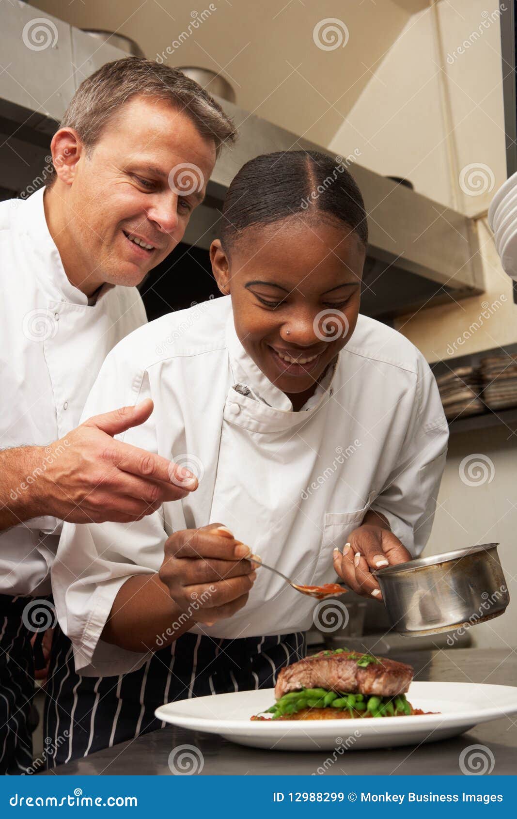 Chef Instructing Trainee in Restaurant Kitchen Stock Image - Image of ...