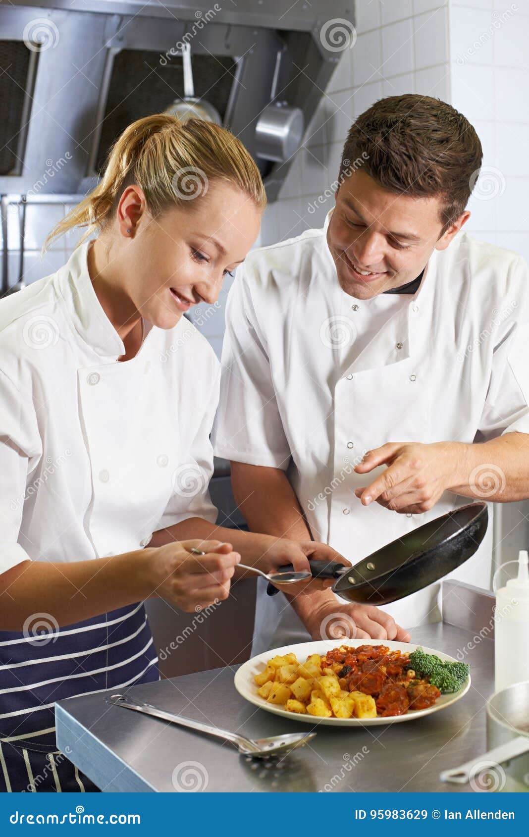 Chef Instructing Trainee in Restaurant Kitchen Stock Image - Image of ...