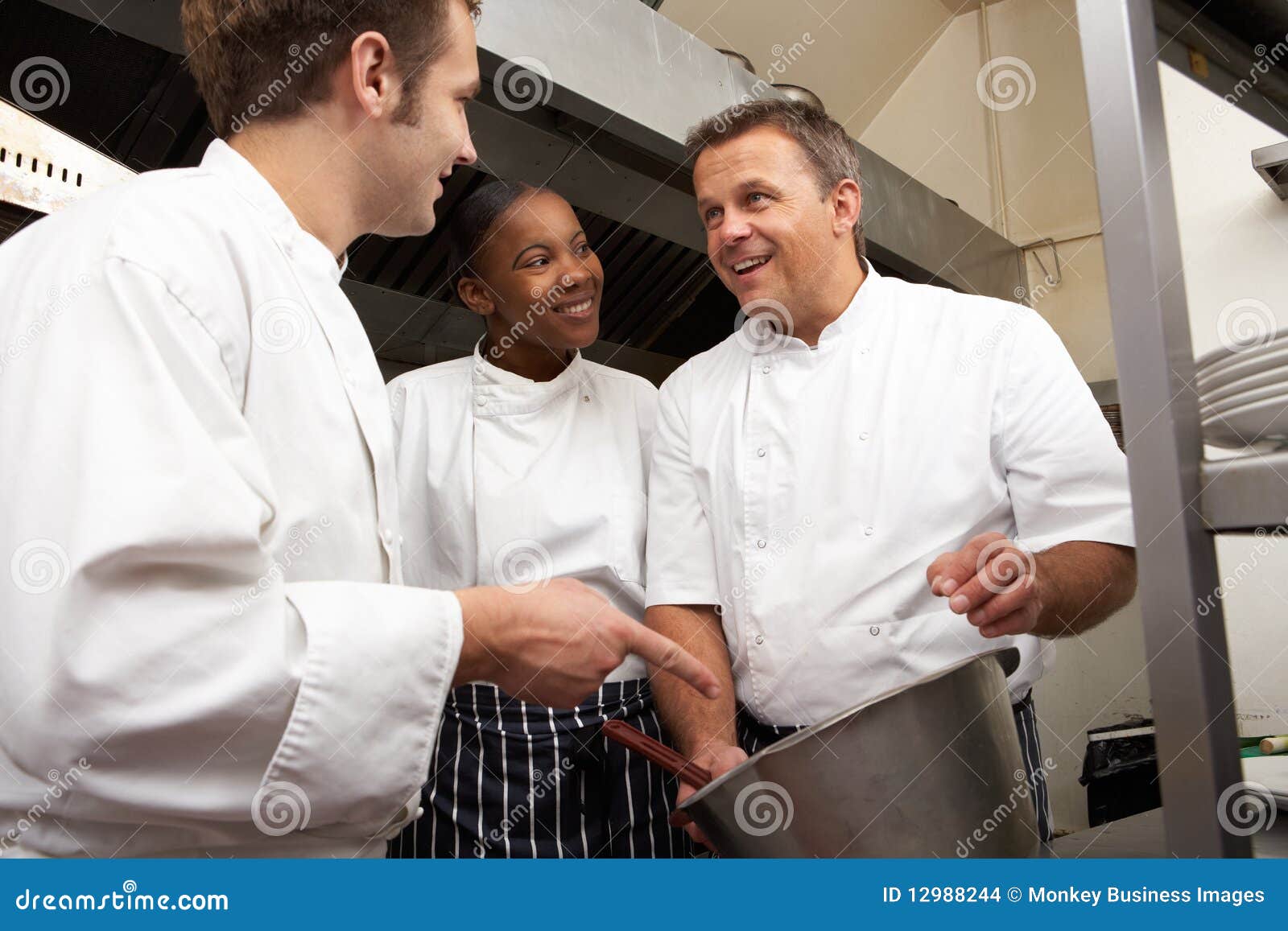 Chef Instructing Trainees in Restaurant Kitchen Stock Photo - Image of ...