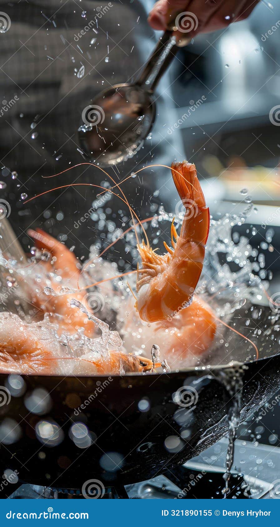 A Chef in a Kitchen Cooking Shrimp in a Wok on a Stovetop Stock Image ...