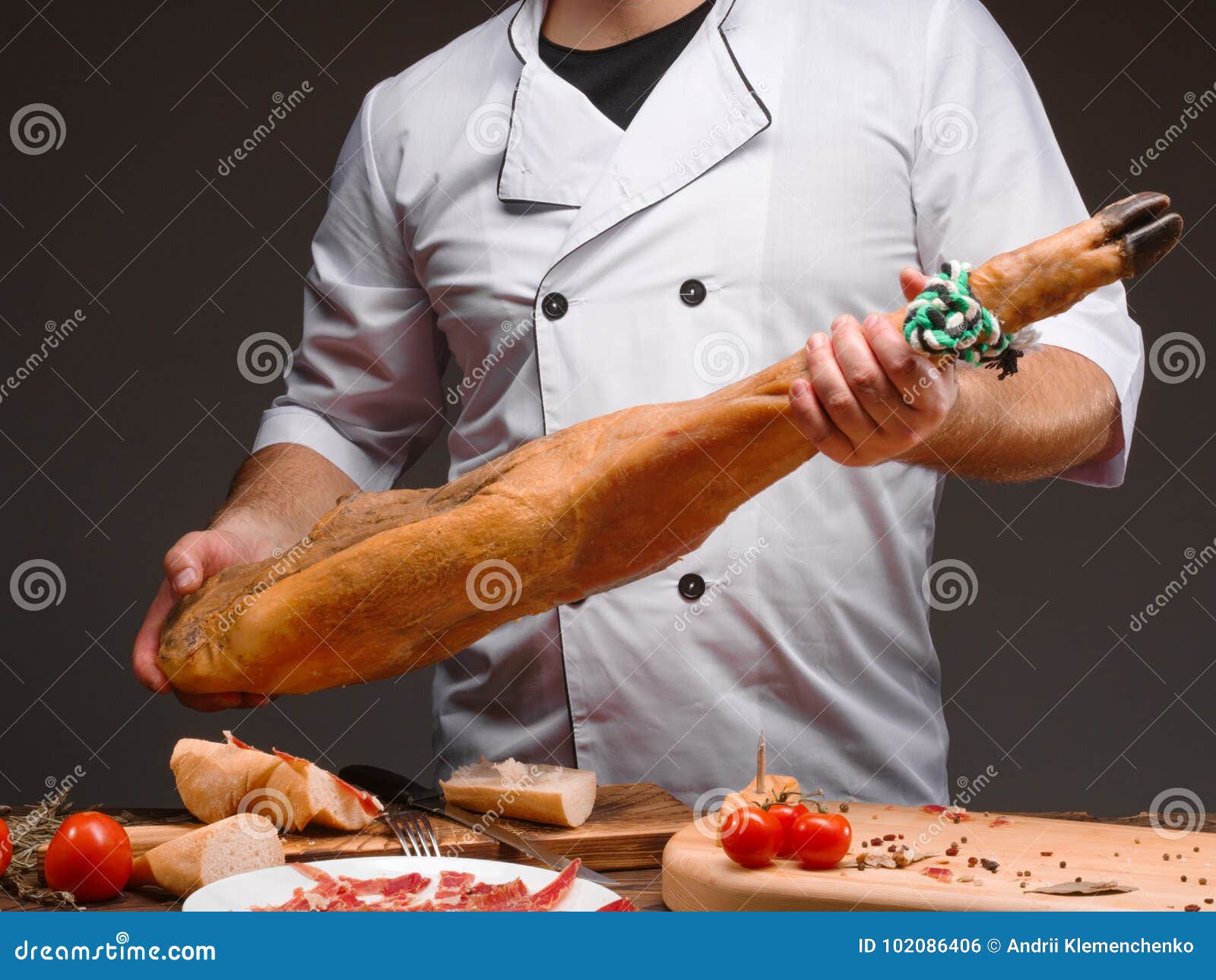 The Chef in the Kitchen with Ham in Hands. Traditional Jamon Stock ...