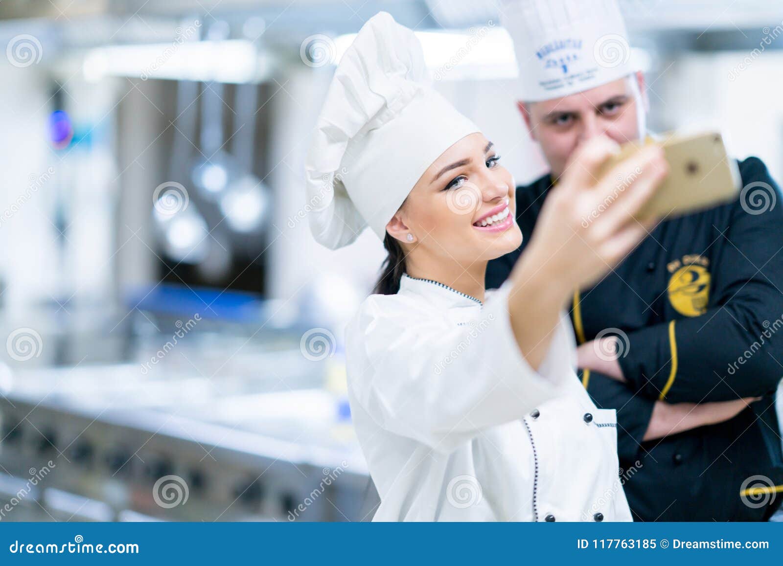 Chef in Kitchen and His Young Assistant Taking Selfie Stock Image ...