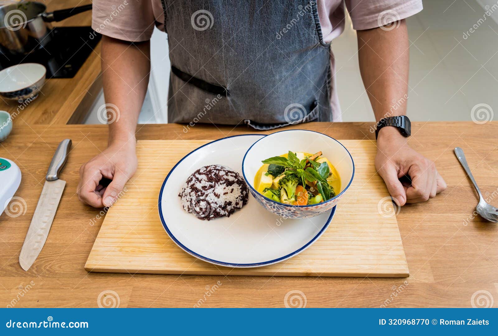 Chef at the Kitchen Preparing Green Curry with Herbs and Rice Stock ...