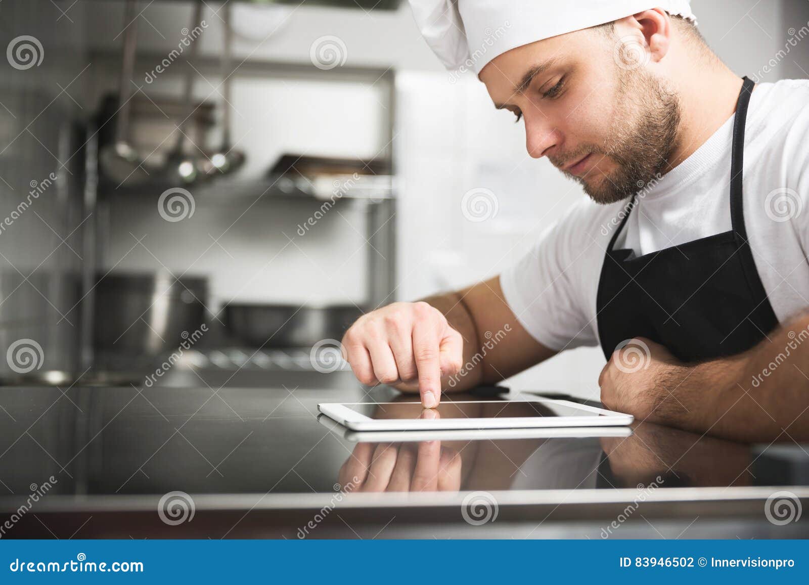 Chef in the Kitchen Using Tablet Stock Photo - Image of intent, closeup ...