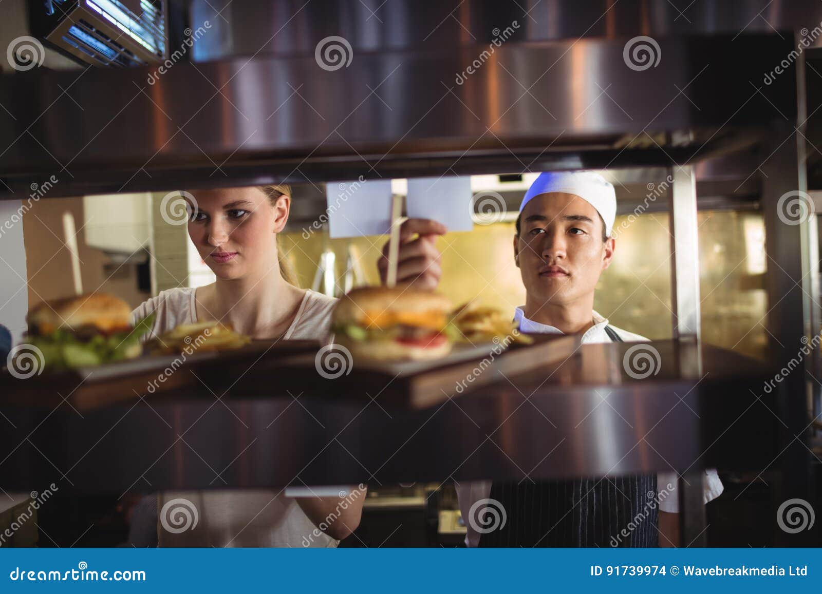 Chef Looking at an Order List in the Commercial Kitchen Stock Photo ...