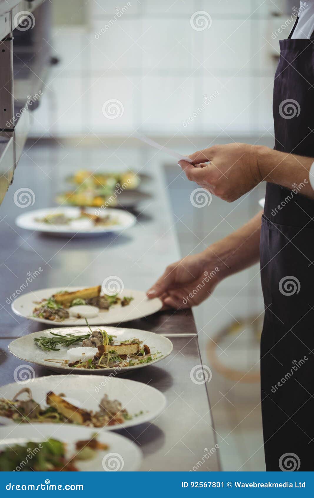 Chef Looking at an Order List in the Commercial Kitchen Stock Image ...