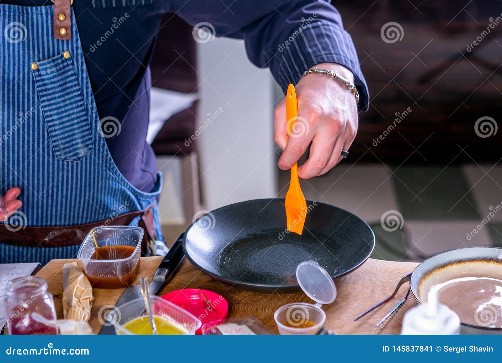 Chef Lubricates the Pan with Oil. Master Class in the Kitchen. the ...