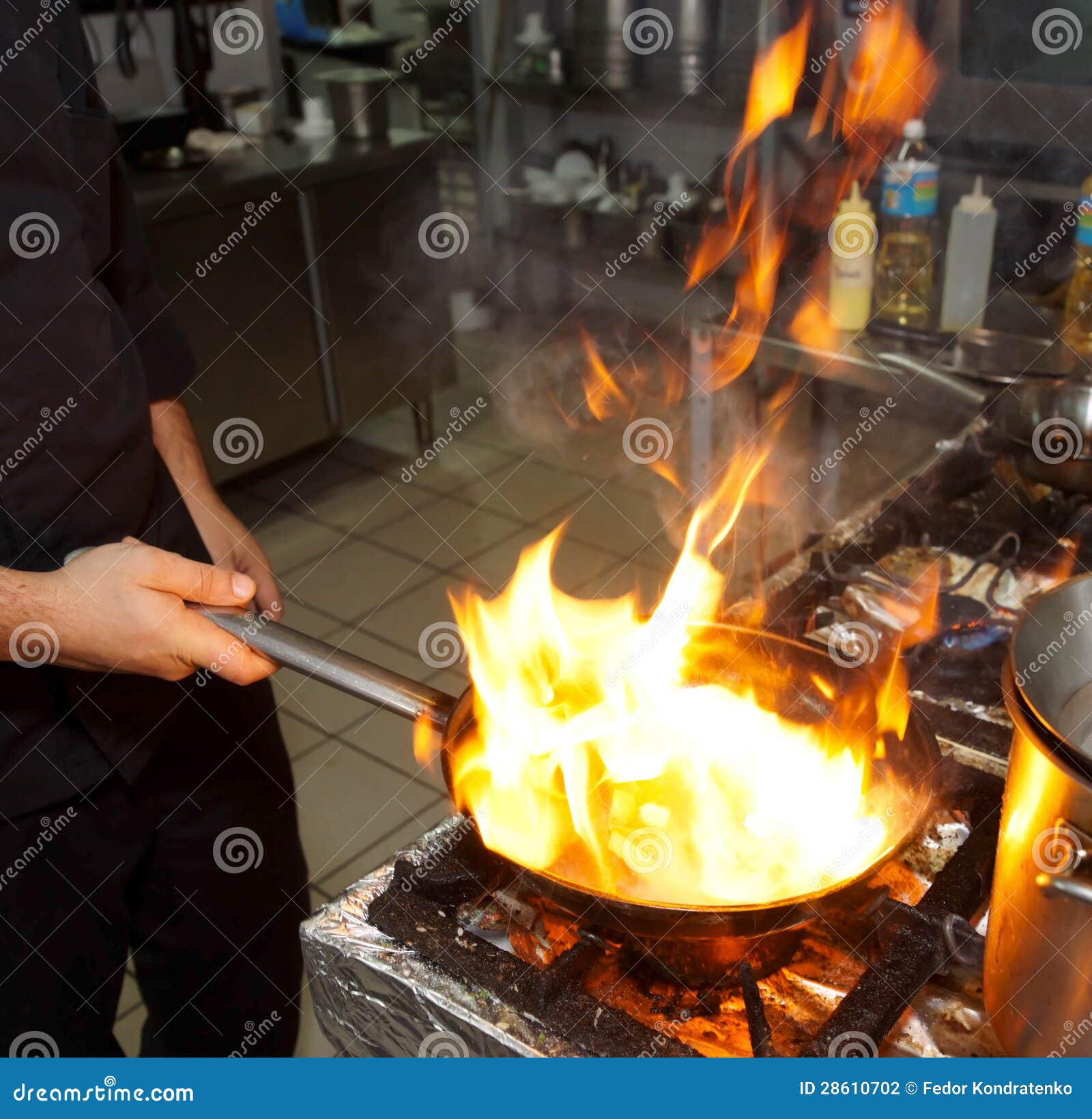 Chef is making flambe dish stock photo. Image of burning - 28610702