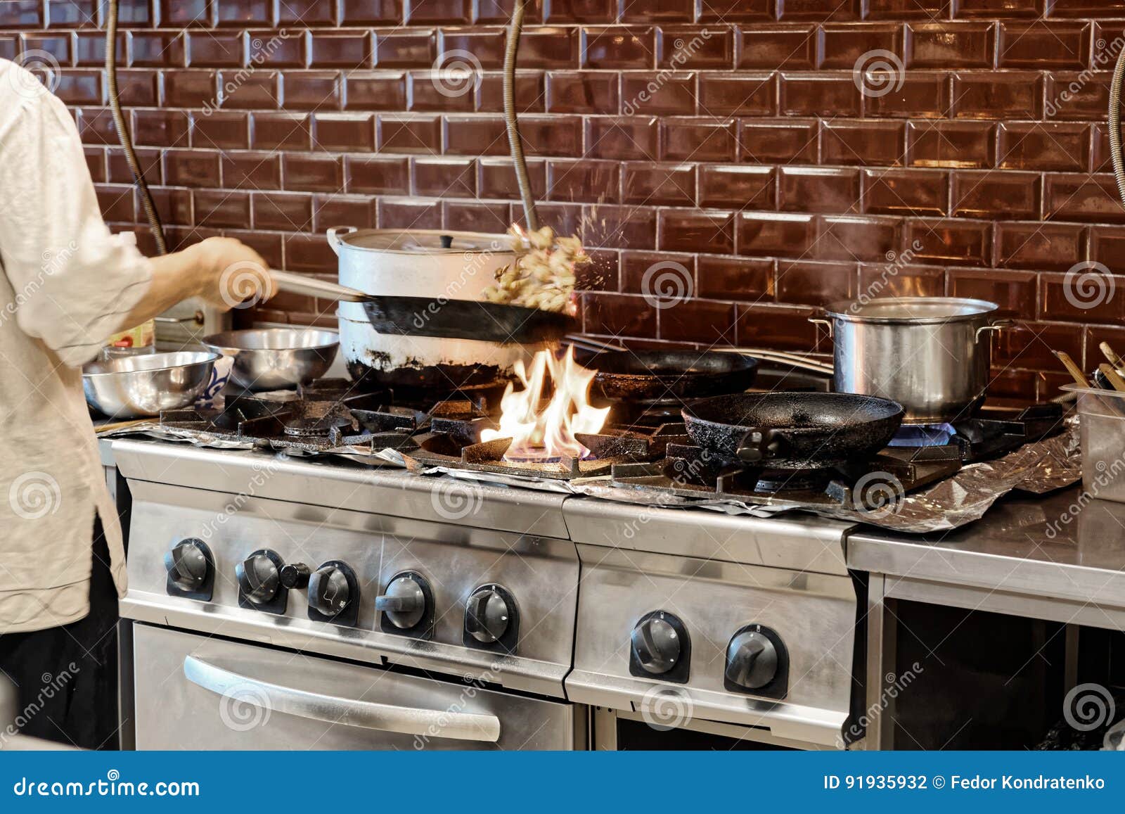 Chef is Making Flambe Dish in Restaurant Kitchen, Toned Stock Photo ...