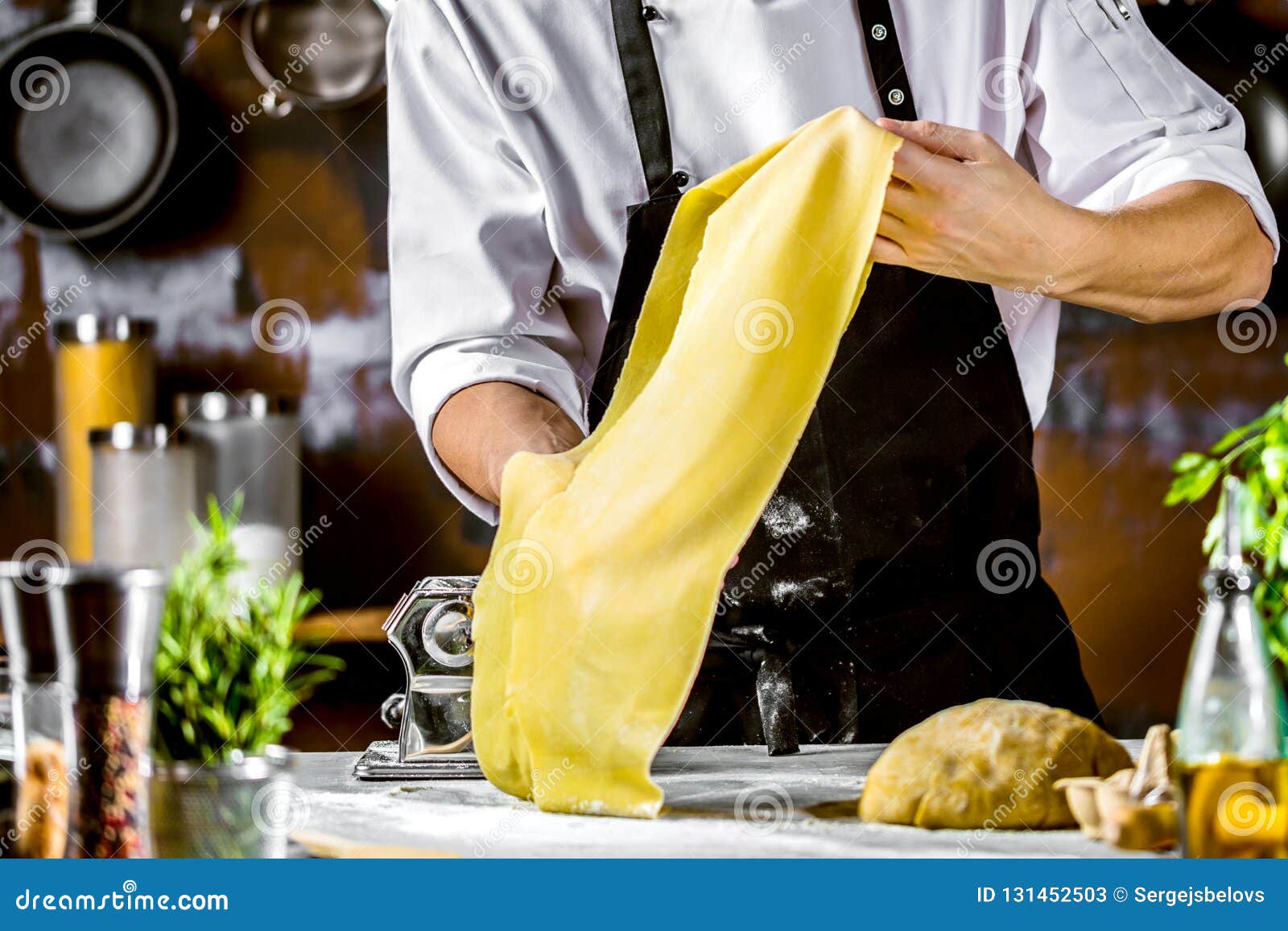 Chef Making Spaghetti Noodles with Pasta Machine on Kitchen Table with ...