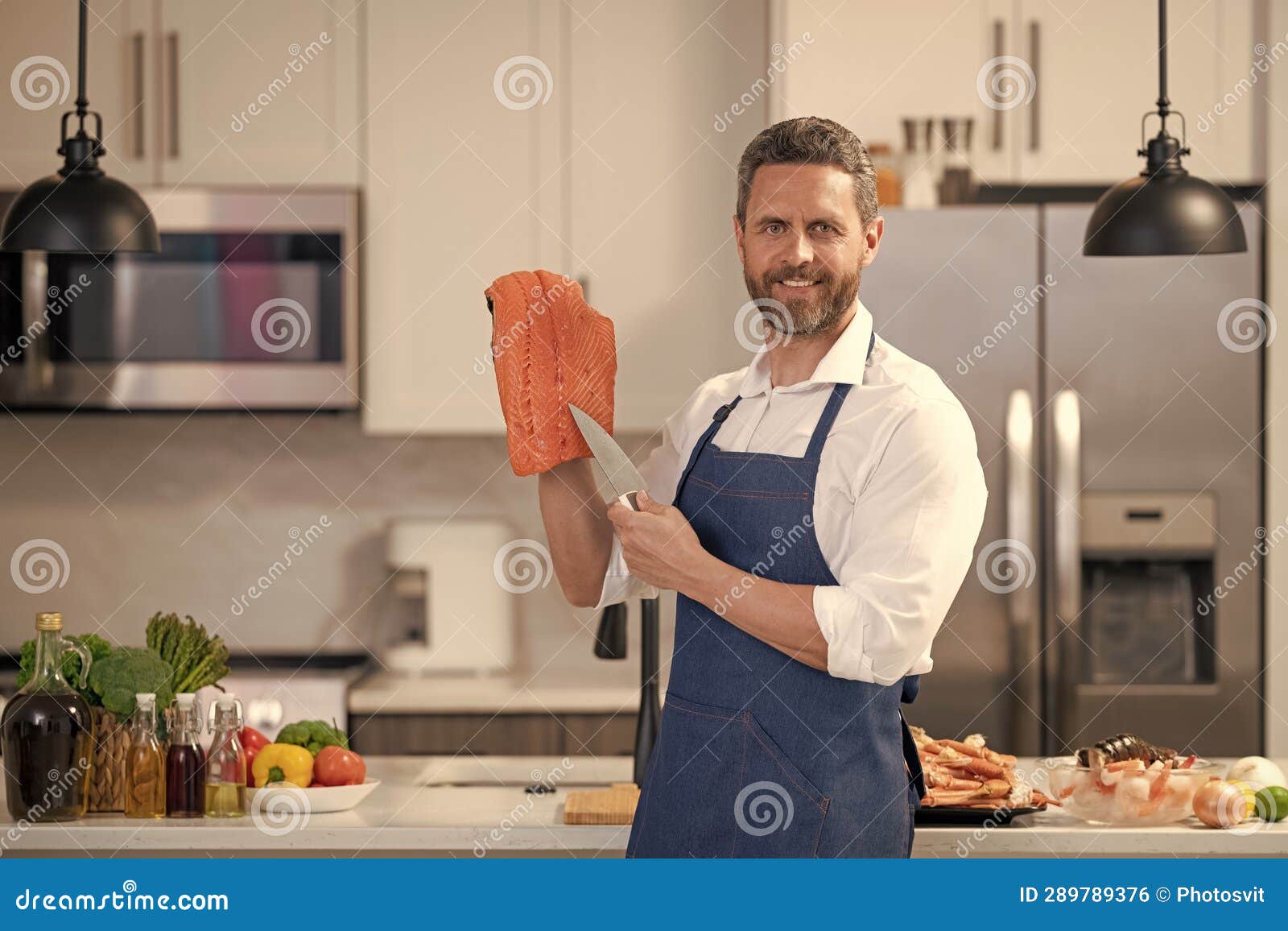 Chef Man Cooking Fish in the Kitchen. Photo of Chef Man Cooking Fish ...