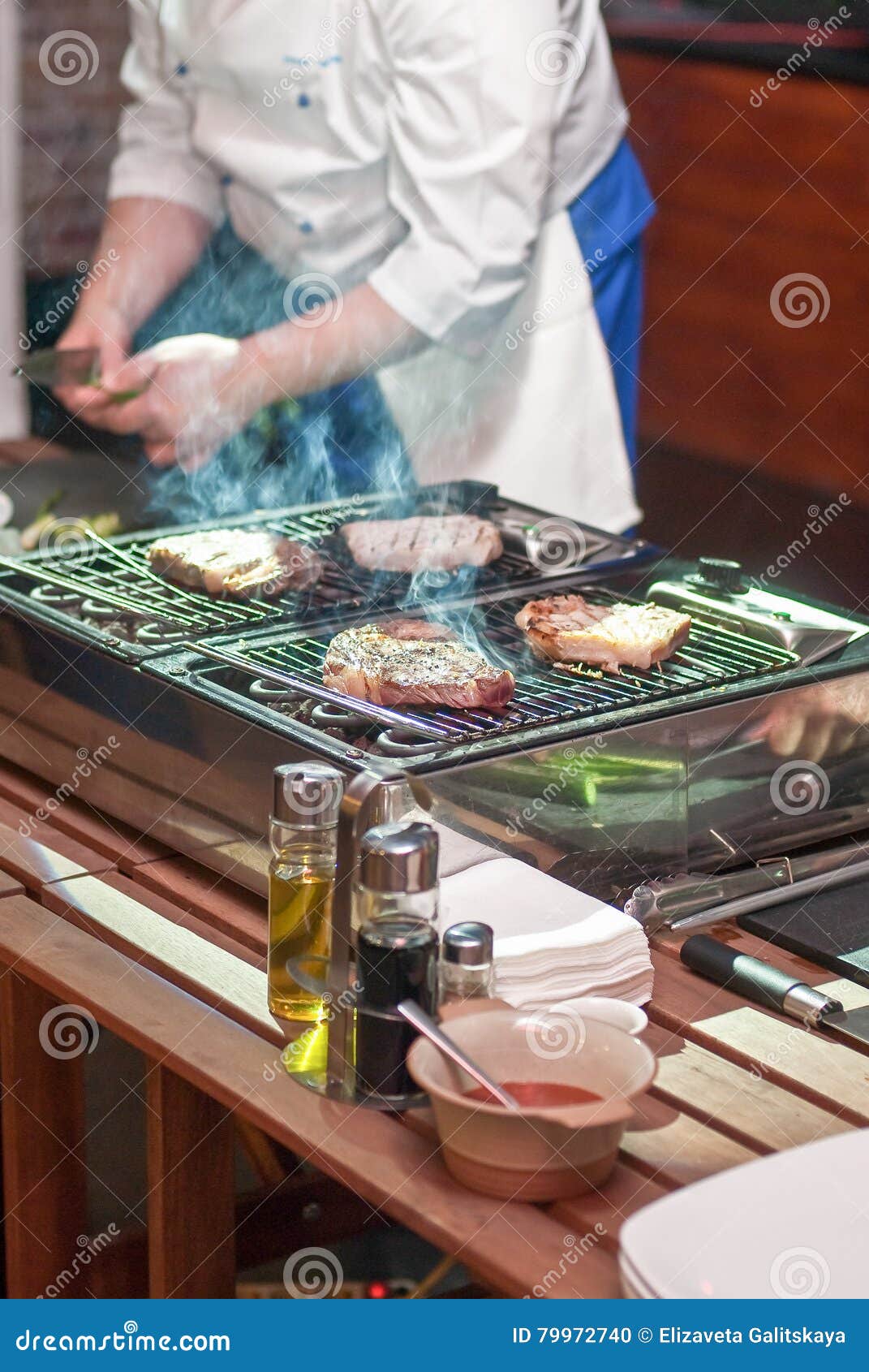 Chef Man in Uniform Frying a Meat Beefsteak Slice on Grill Stock Photo ...