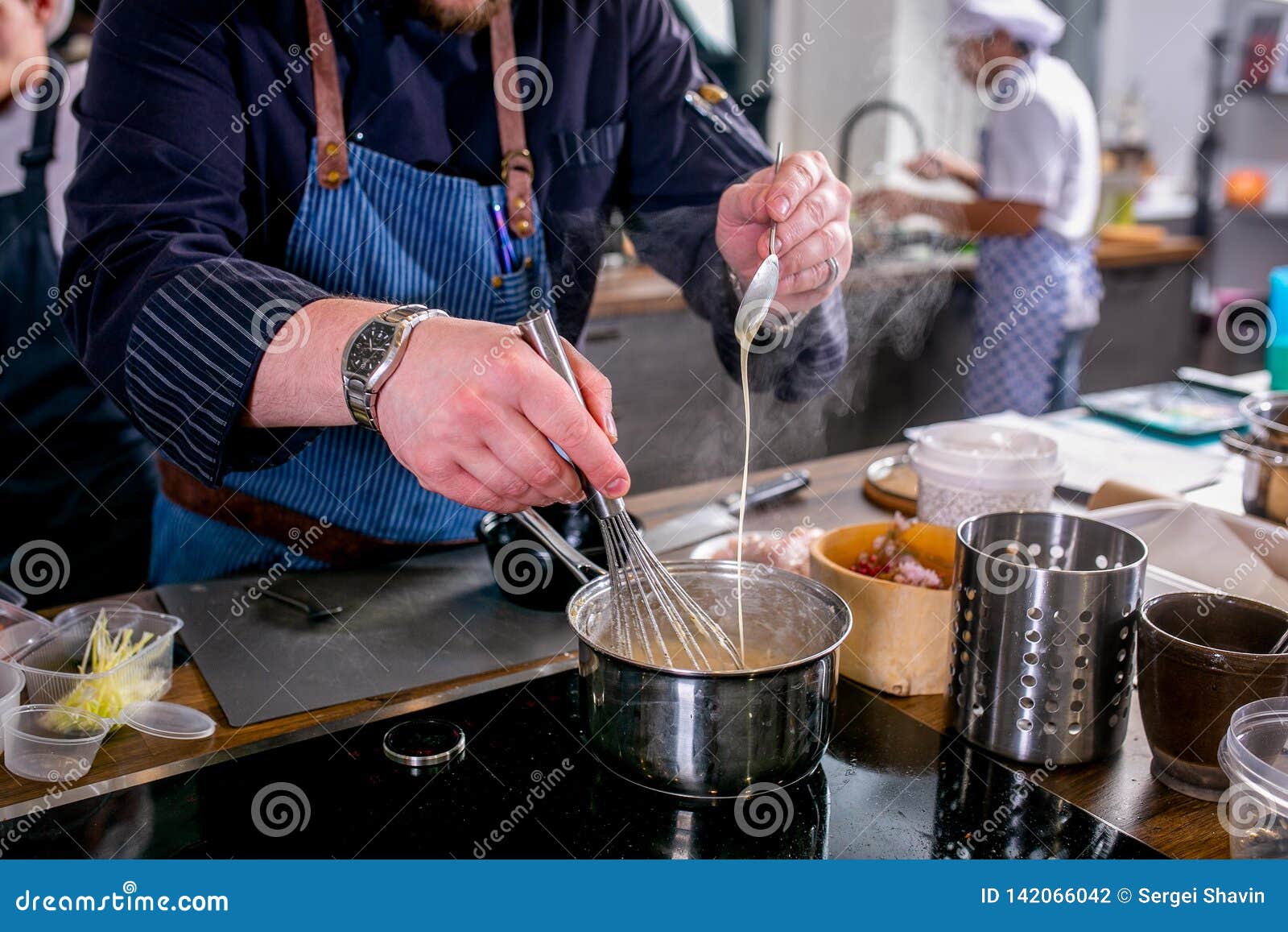 The Chef Mixes the Sauce in a Saucepan Using the Whisk. Master Class in ...