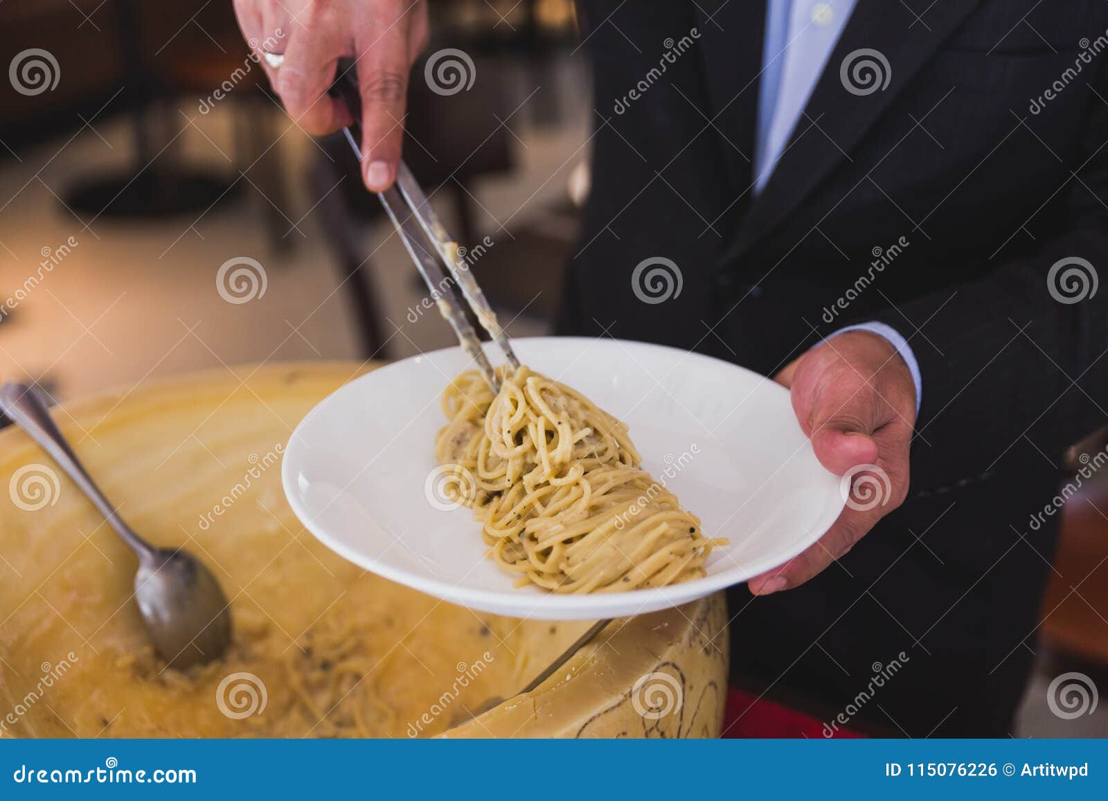 Chef Neatly Plating Spaghetti Carbonara in Cheese Wheel on White Plate ...