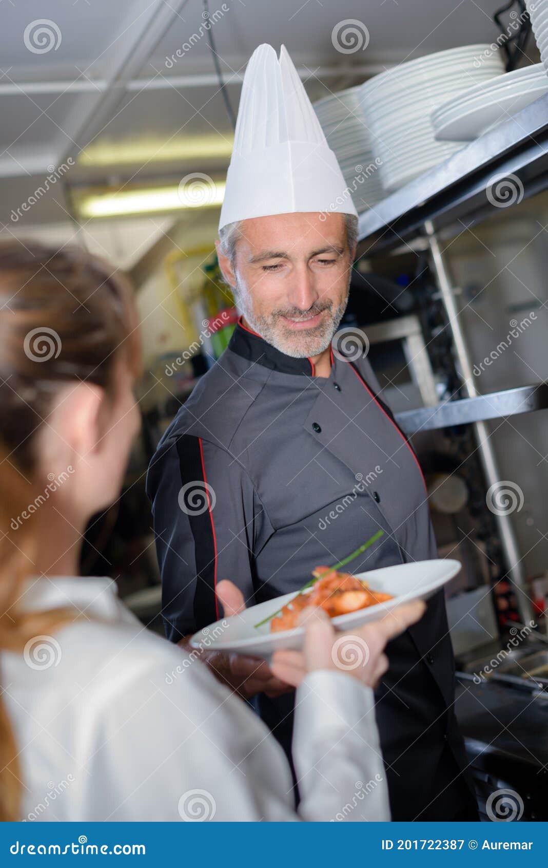 Chef Passing Dish To Waitress Stock Image - Image of kitchen, female ...