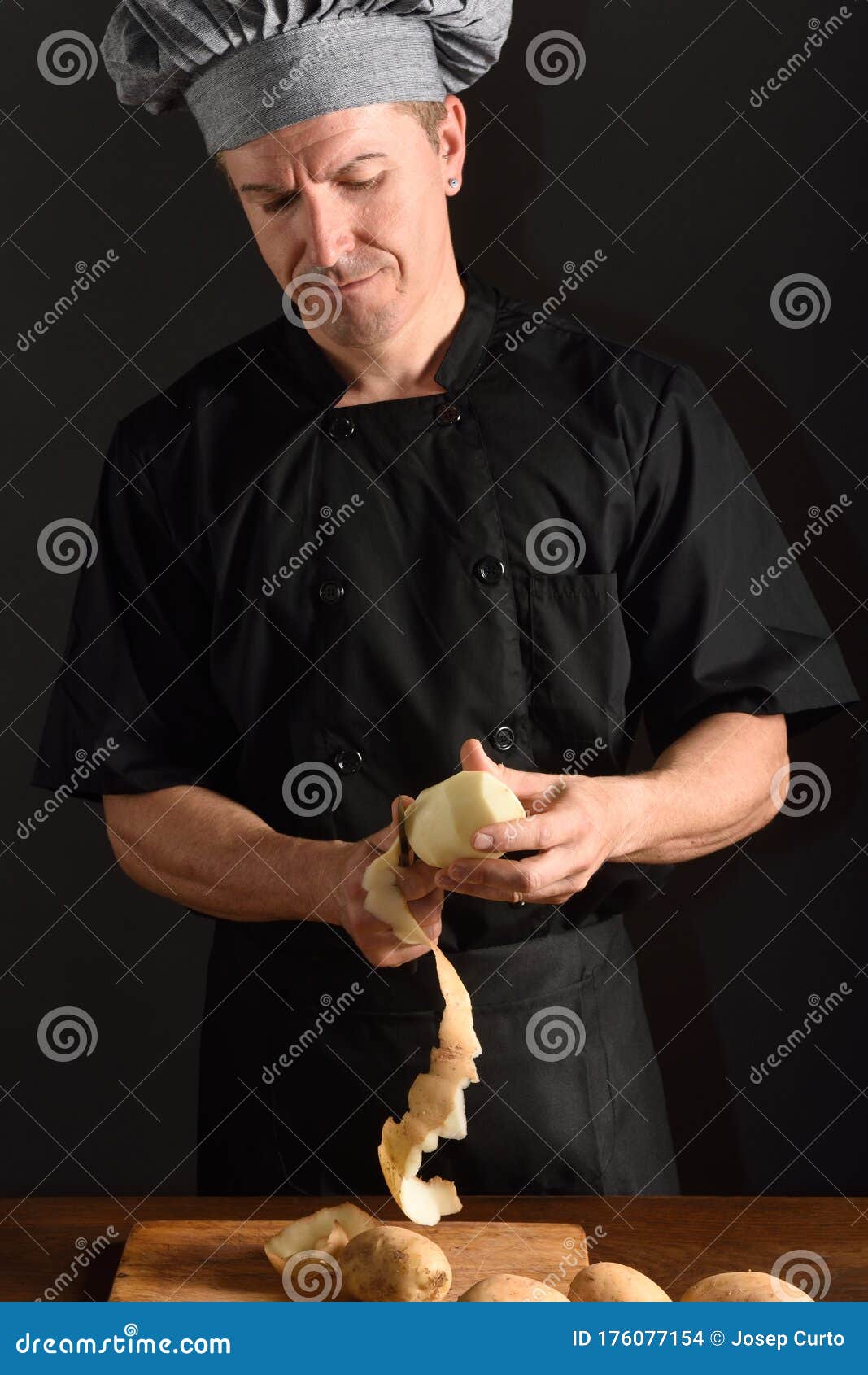 Chef peeling potatoes stock photo. Image of healthy - 176077154