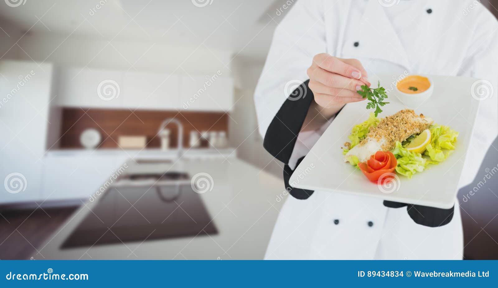 Chef with Plate of Food Against Blurry Kitchen Stock Photo - Image of ...