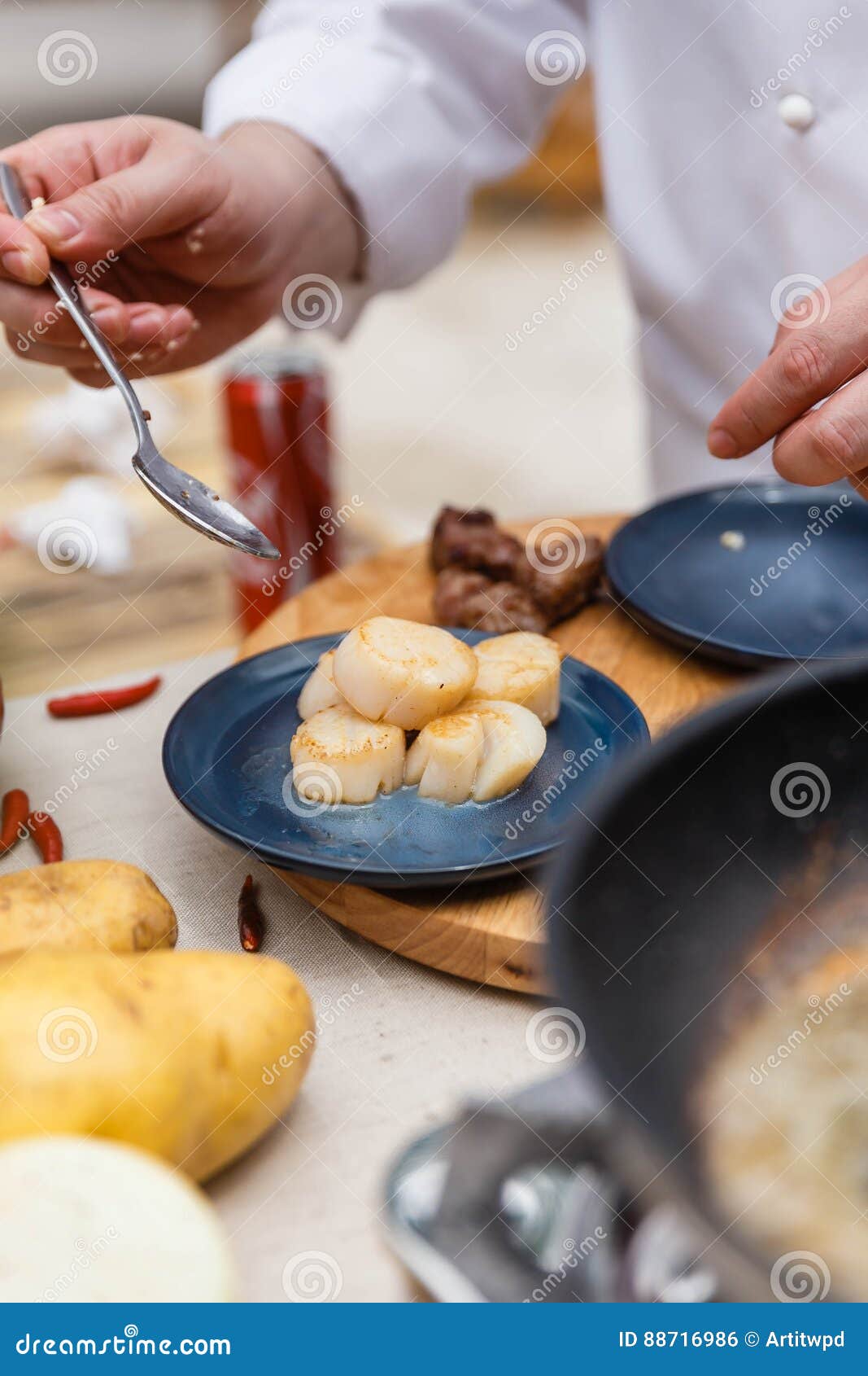 Chef Plating Fried Scallops in Blue Ceramic Plate Stock Photo - Image ...