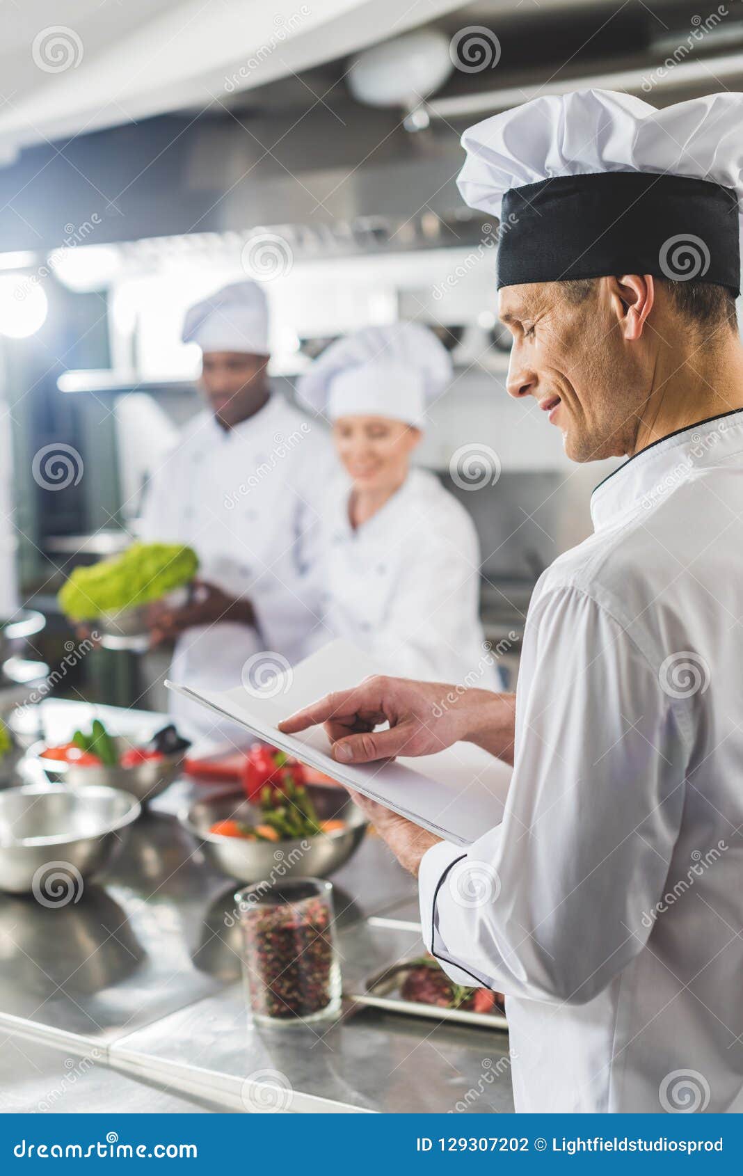 Chef Pointing on Recipe Book Stock Photo - Image of people ...